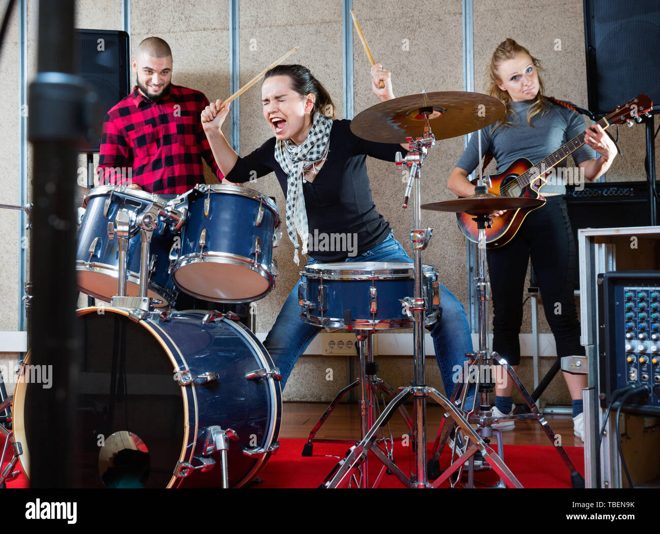 Passionate emotional cheerful positive smiling female drummer with her ...