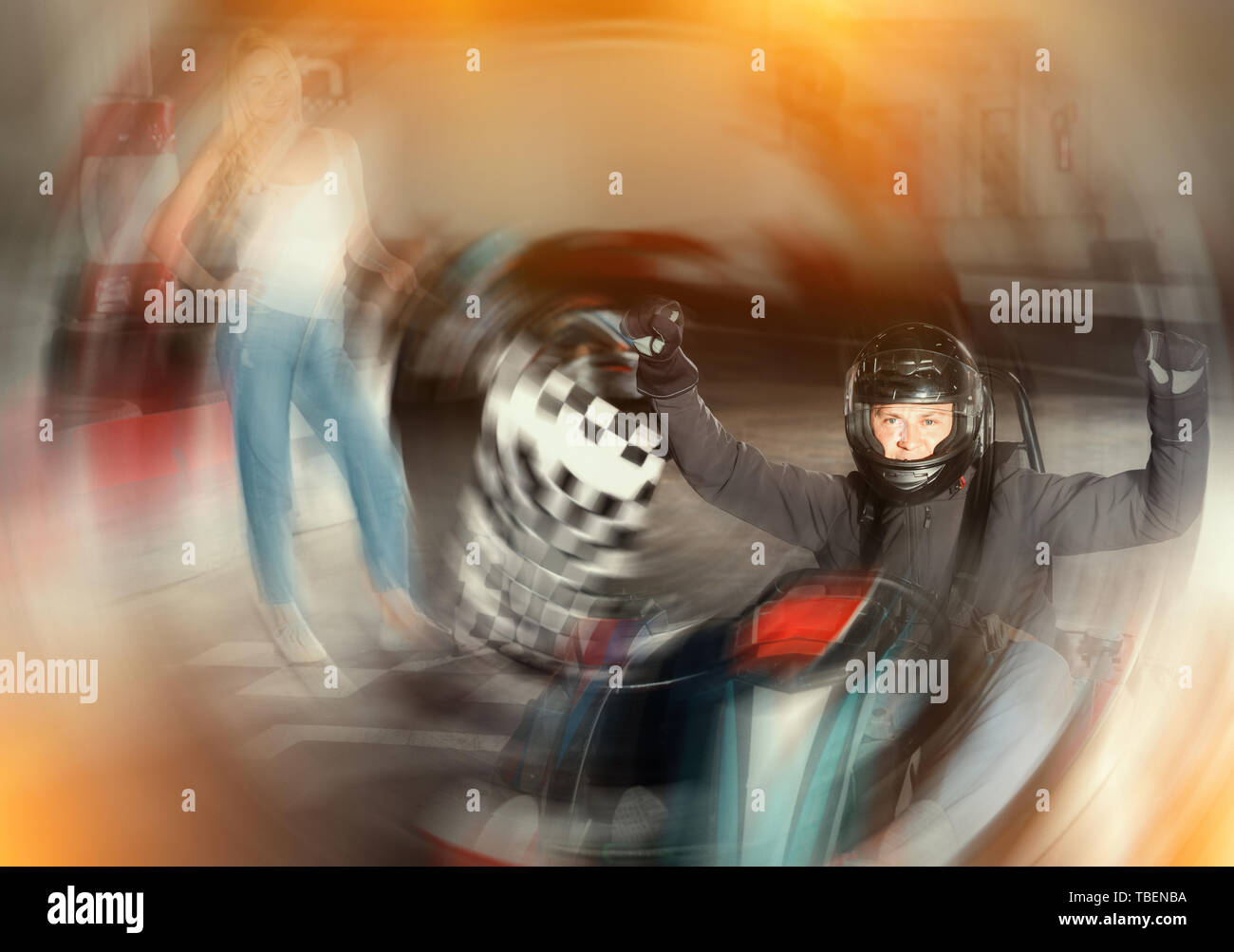 Happy cheerful positive man finishing race on racing car at kart ...
