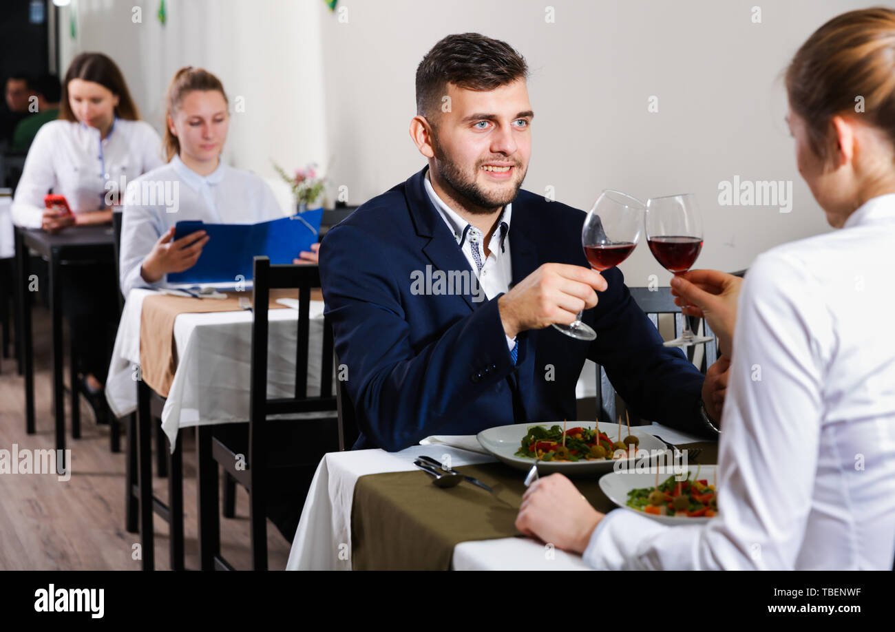 Elegant female and her boyfriend are celebrating date for dinner in ...