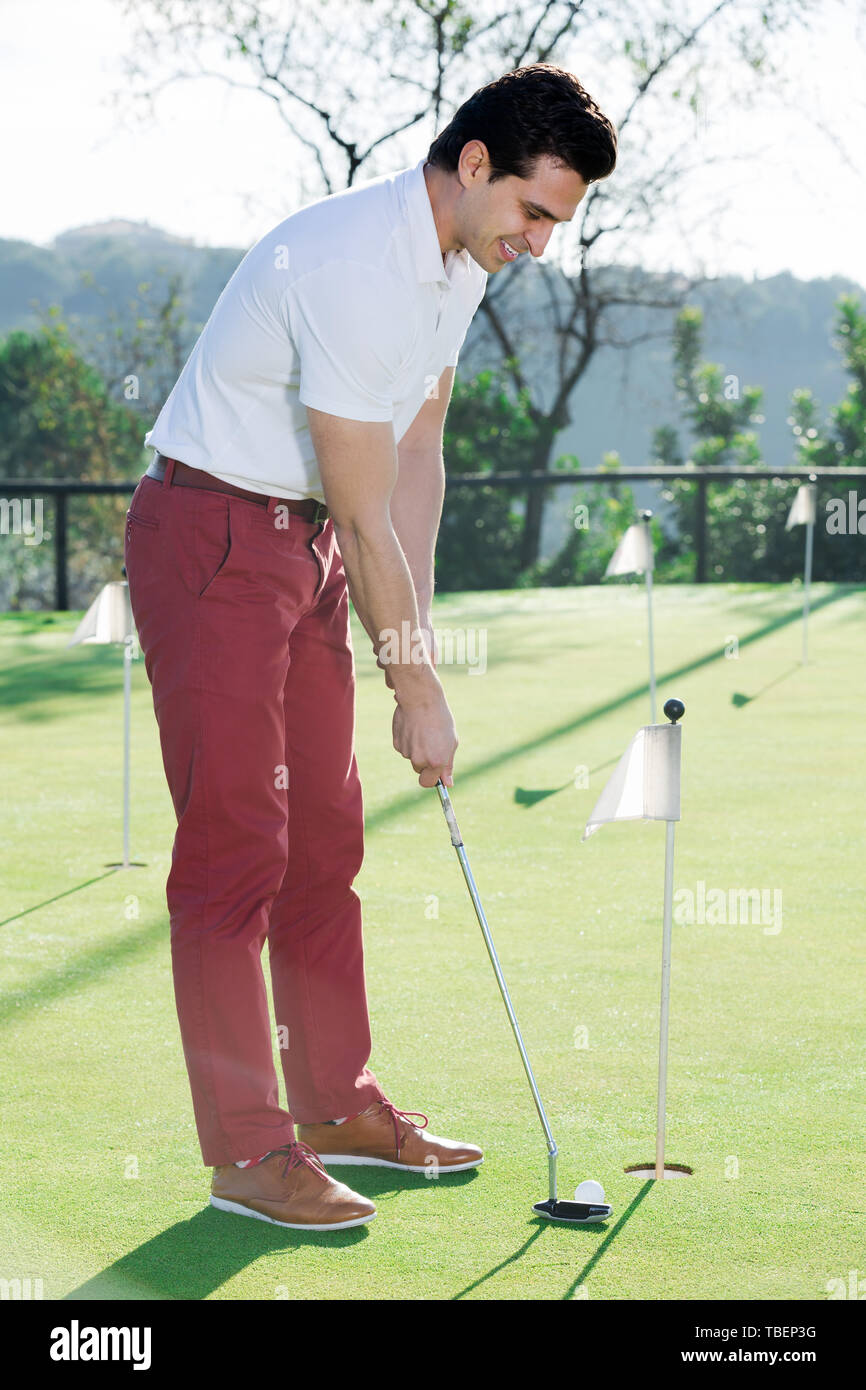 Male golfer getting ready to hit ball at golf course Stock Photo - Alamy
