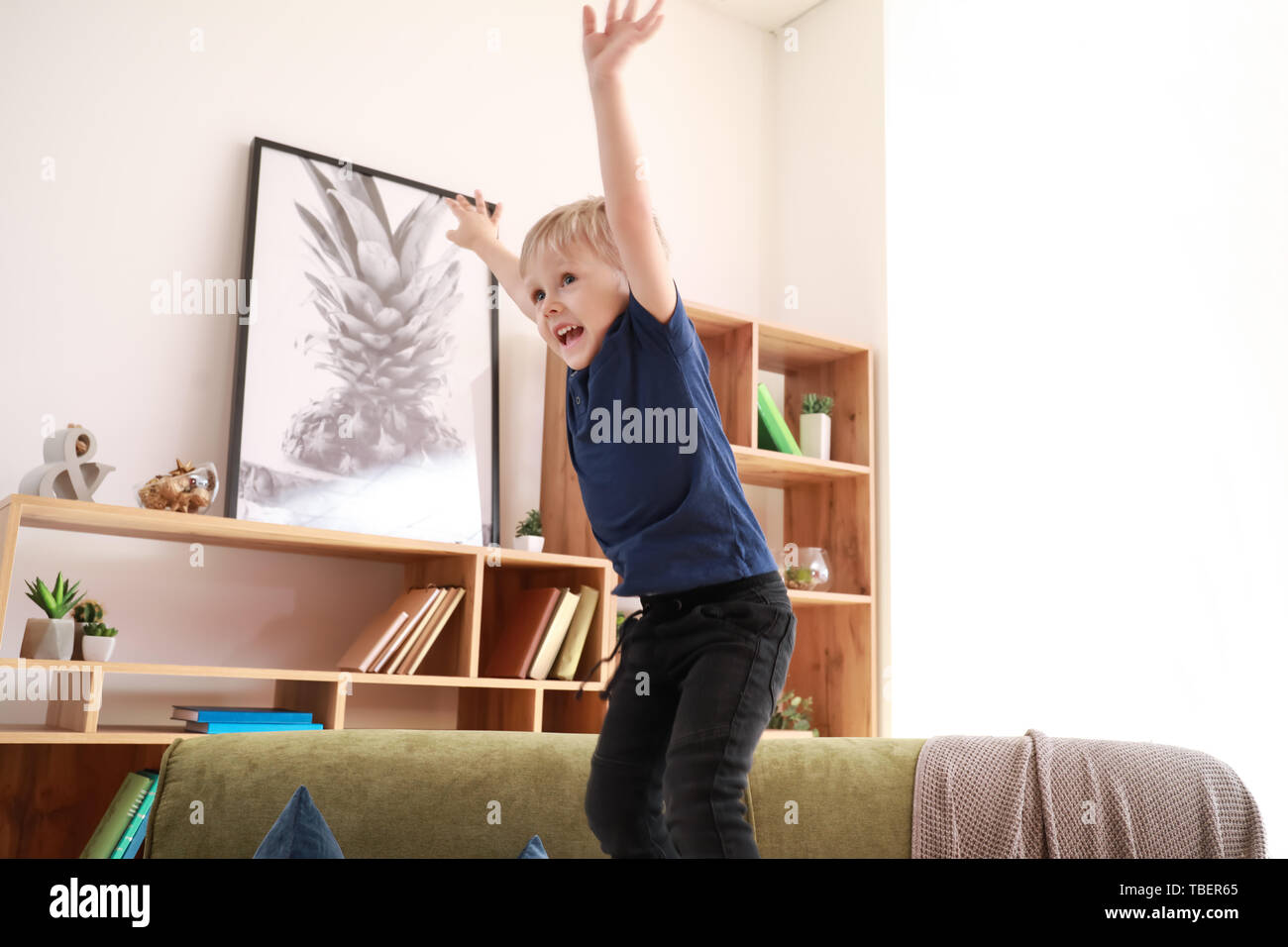 Happy little boy jumping at home Stock Photo - Alamy