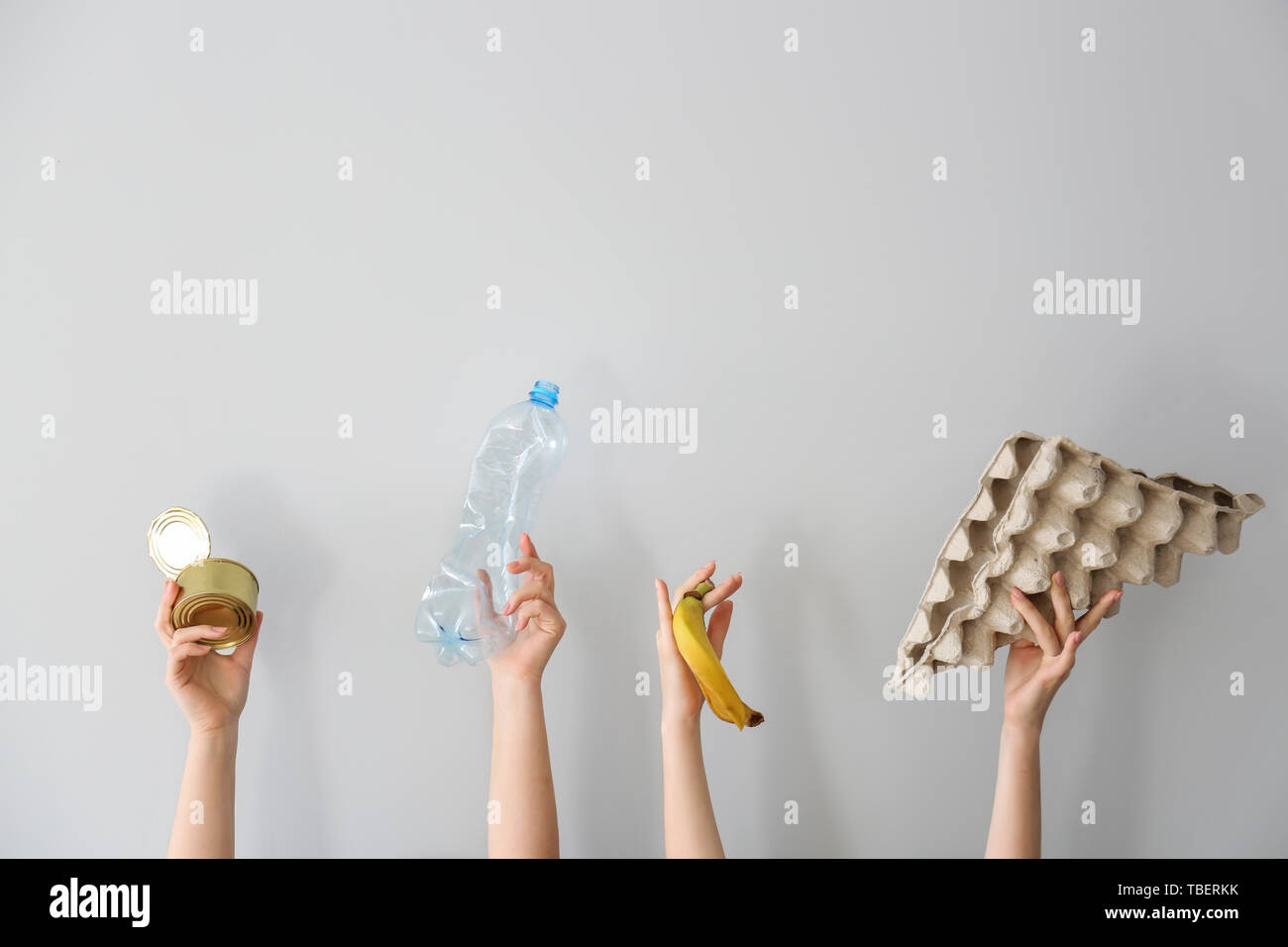 Hands with different types of garbage on white background Stock Photo ...