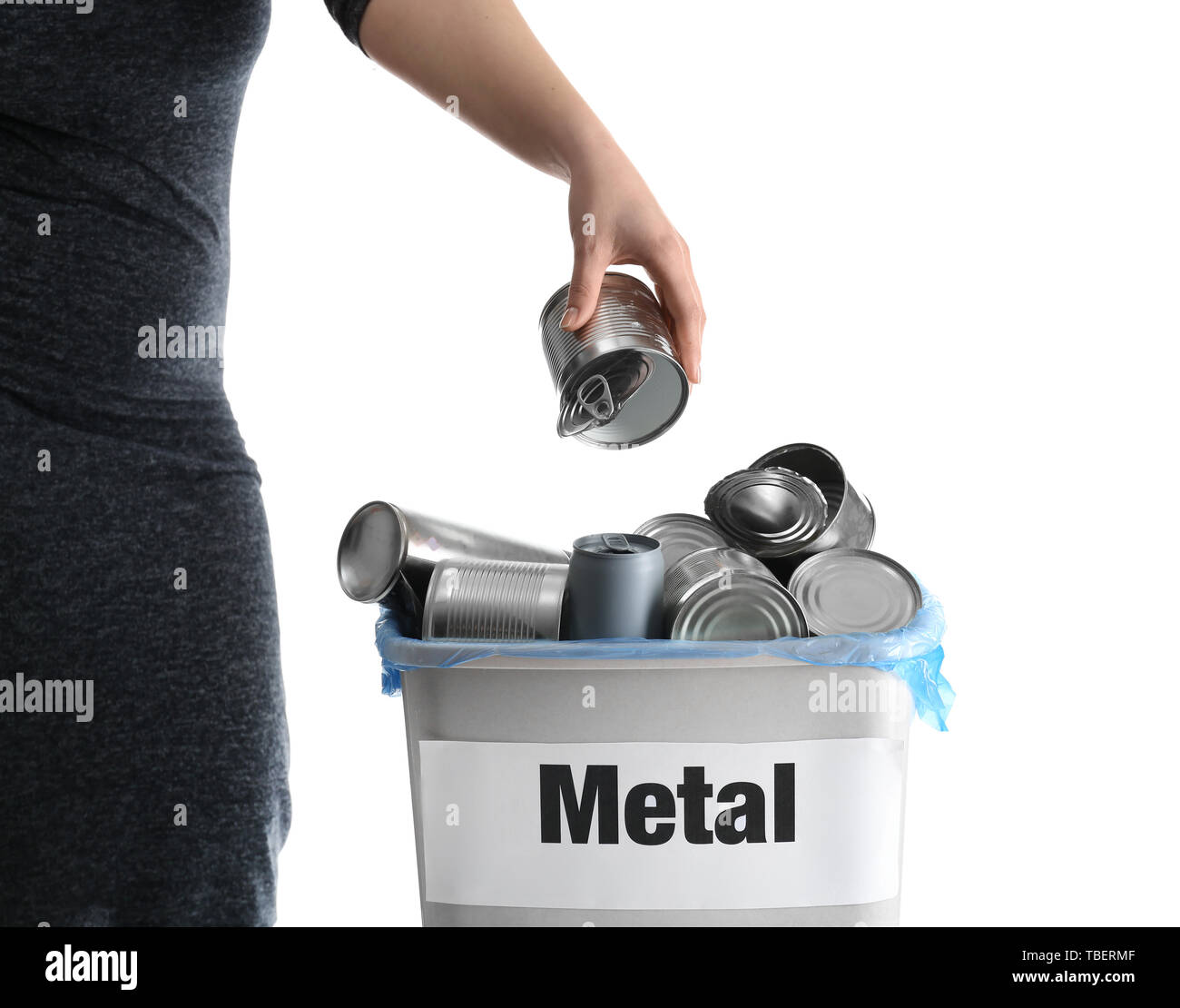 Woman throwing cans in trash bin on white background Stock Photo - Alamy