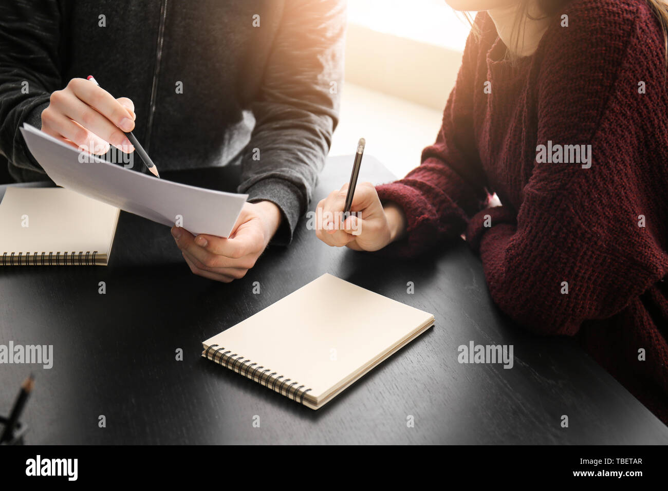 Colleagues sitting at table during business meeting in conference hall ...
