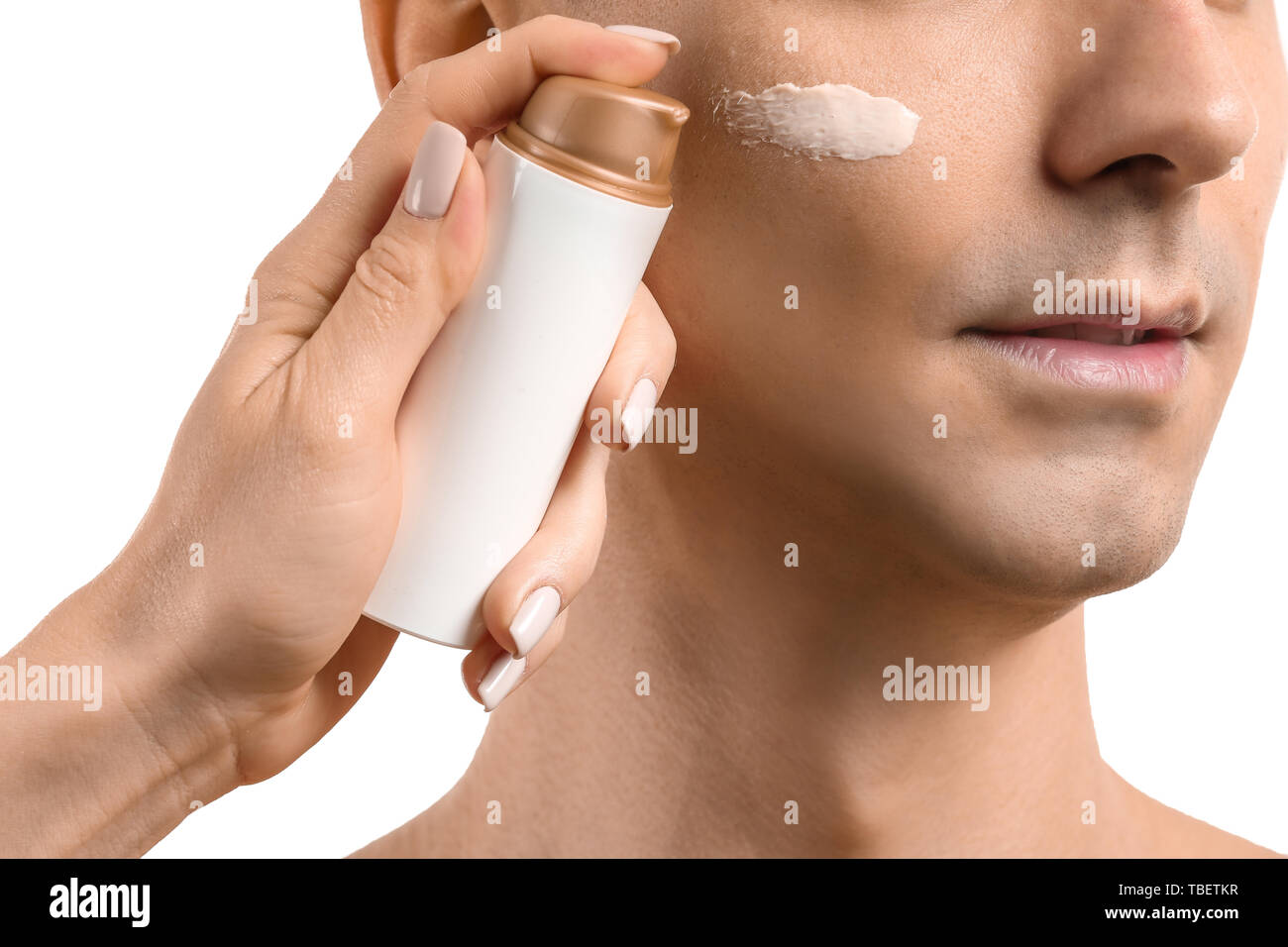 Female hand applying serum onto man's face against white background ...
