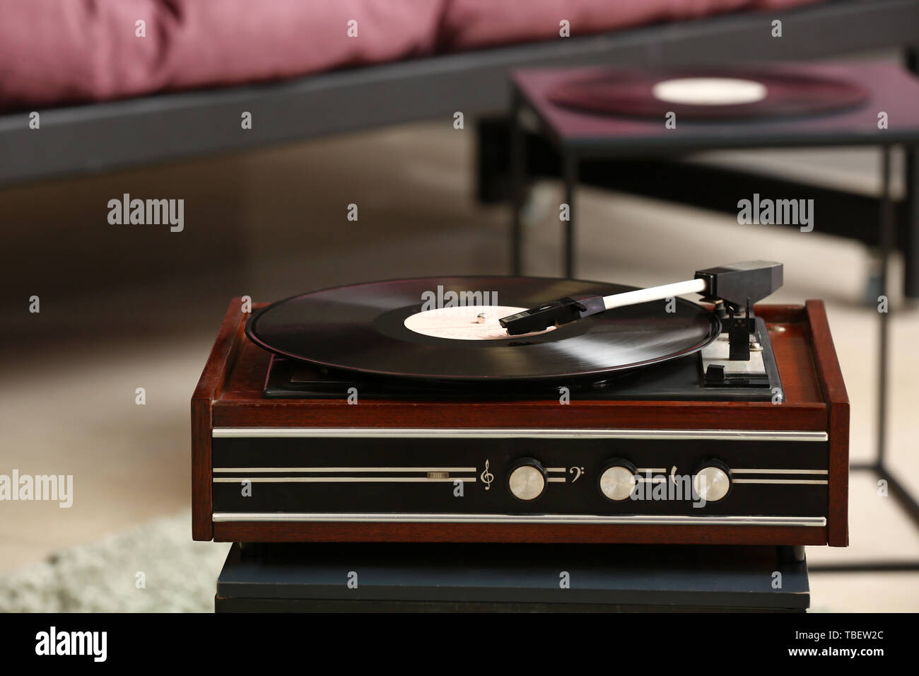 Old record player with vinyl disc on table in room Stock Photo - Alamy