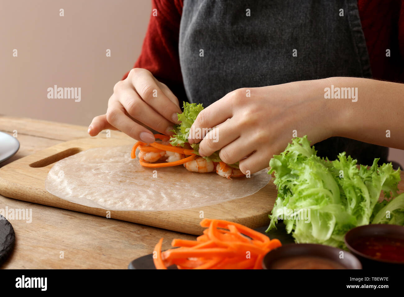 Hands wrapping spring rolls hi-res stock photography and images - Alamy