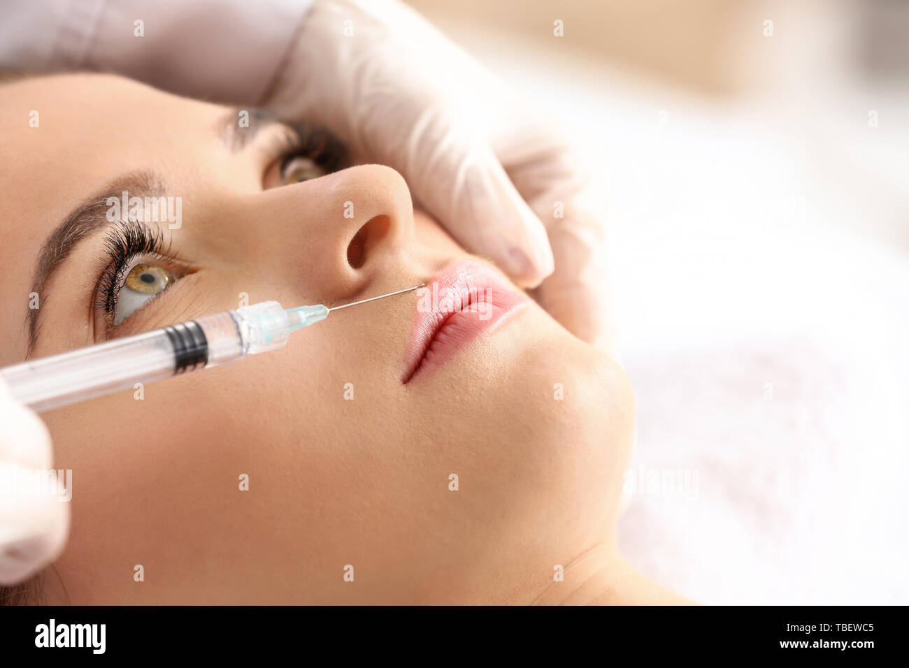 Young woman receiving filler injection in beauty salon Stock Photo - Alamy