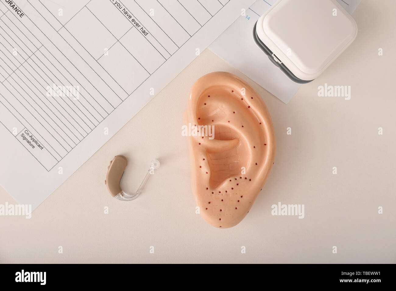 Box with hearing aid and model of ear on table of doctor Stock Photo ...