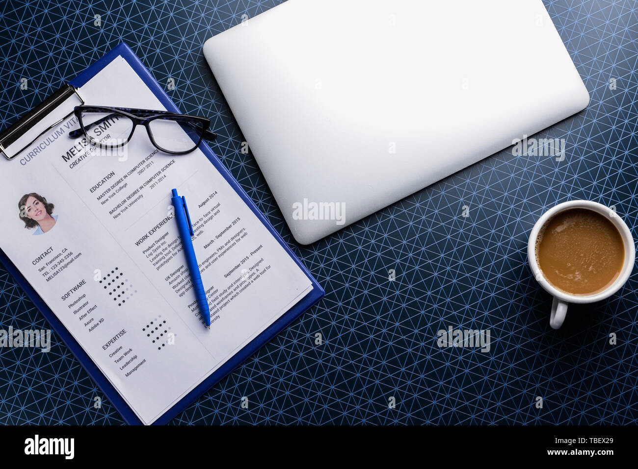 Job resume with laptop and cup of coffee on color background Stock ...