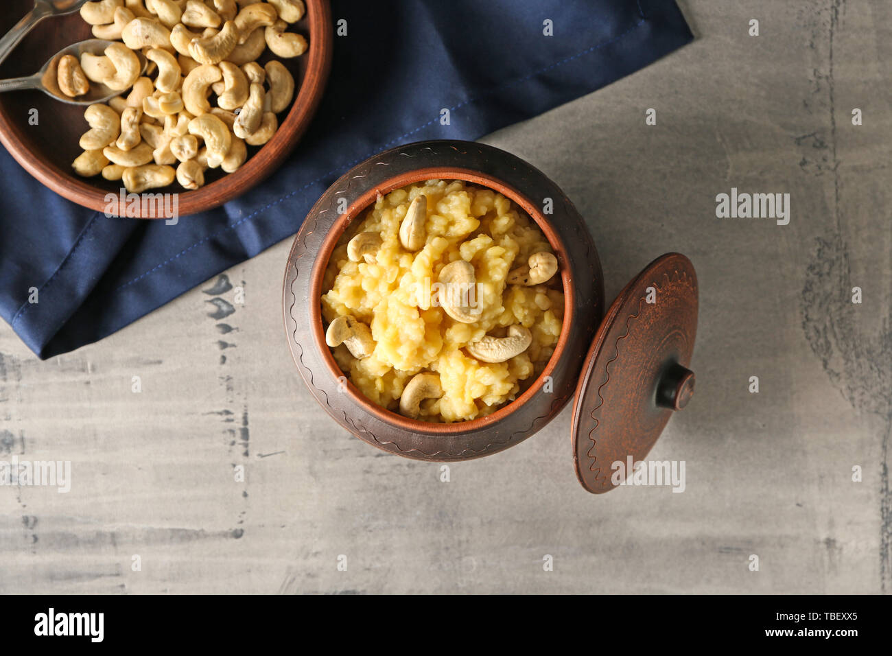 Pot with traditional Indian food pongal on table Stock Photo - Alamy