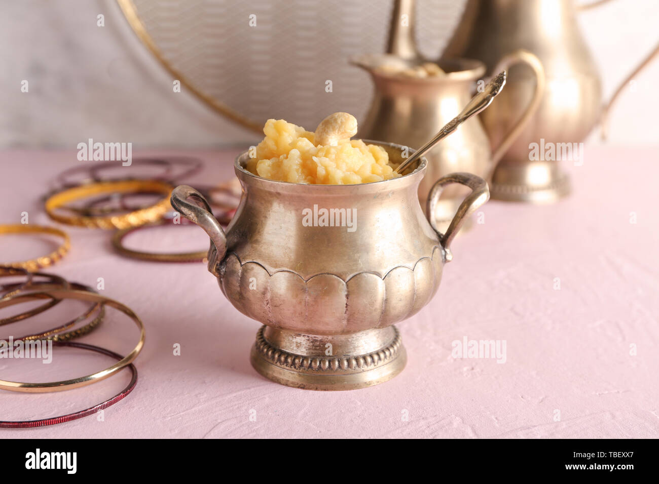 Pot with traditional Indian food pongal on table Stock Photo - Alamy