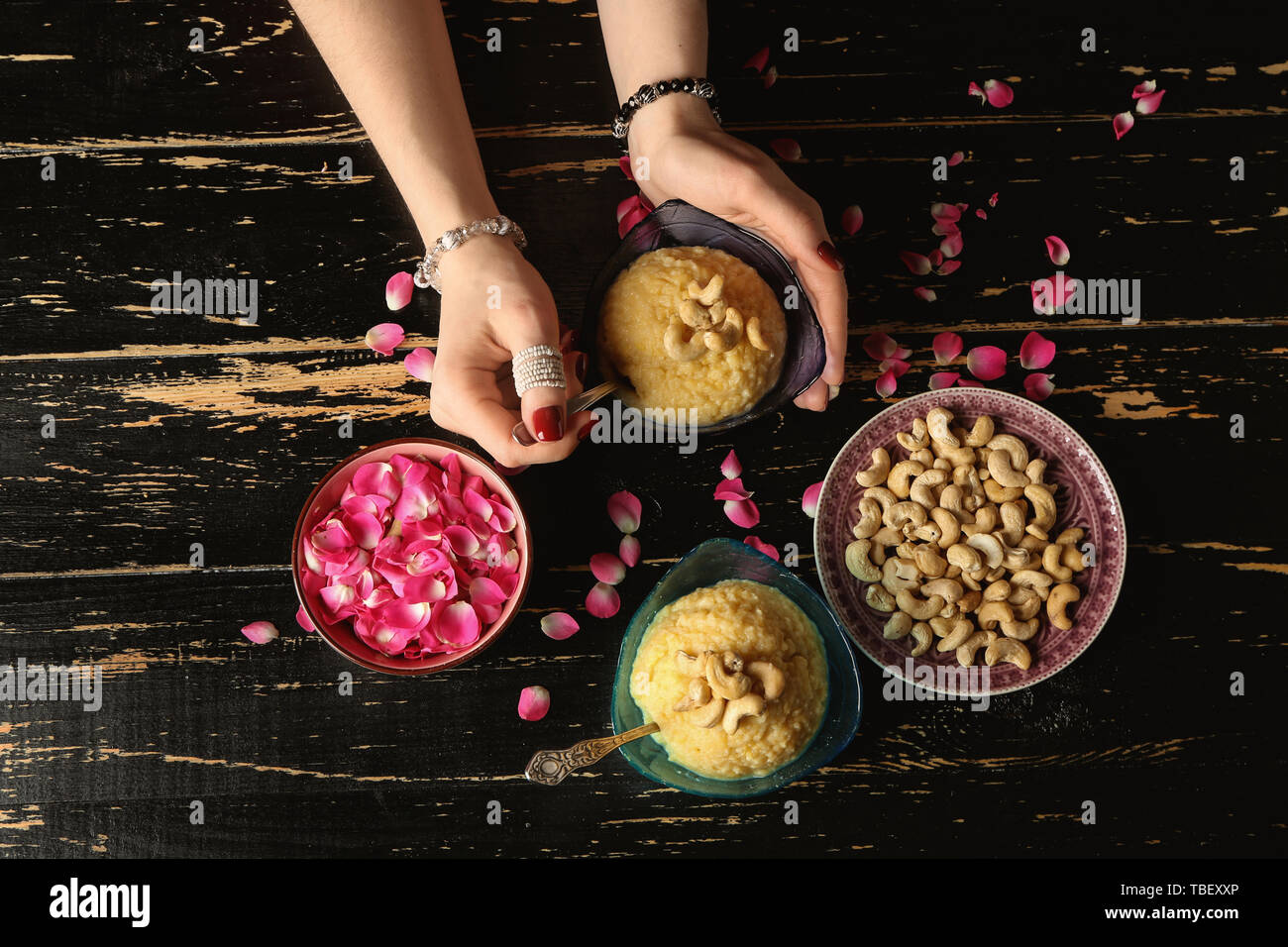 Woman with traditional Indian food pongal at table, top view Stock ...