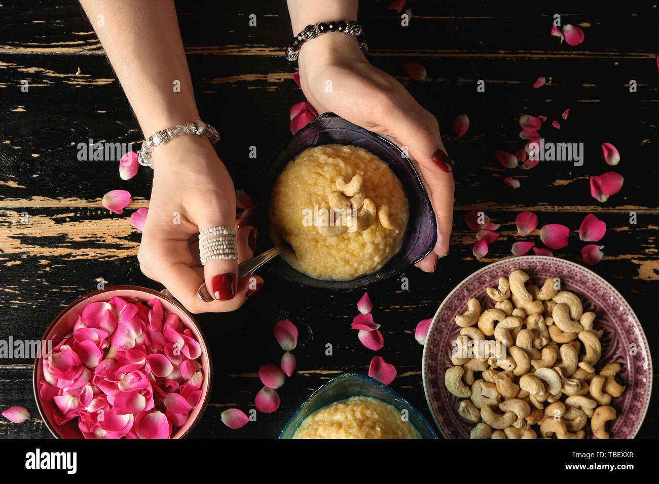 Woman with traditional Indian food pongal at table, top view Stock ...