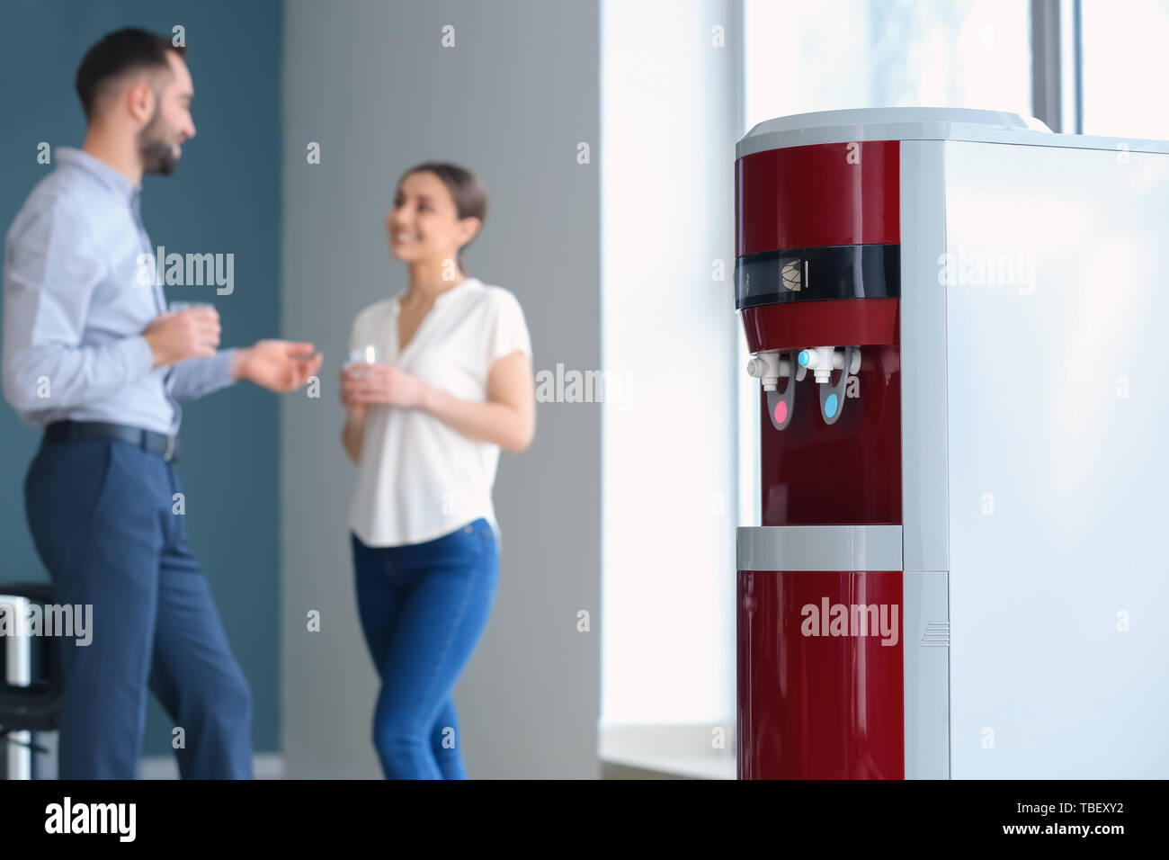 Modern water cooler in office Stock Photo - Alamy