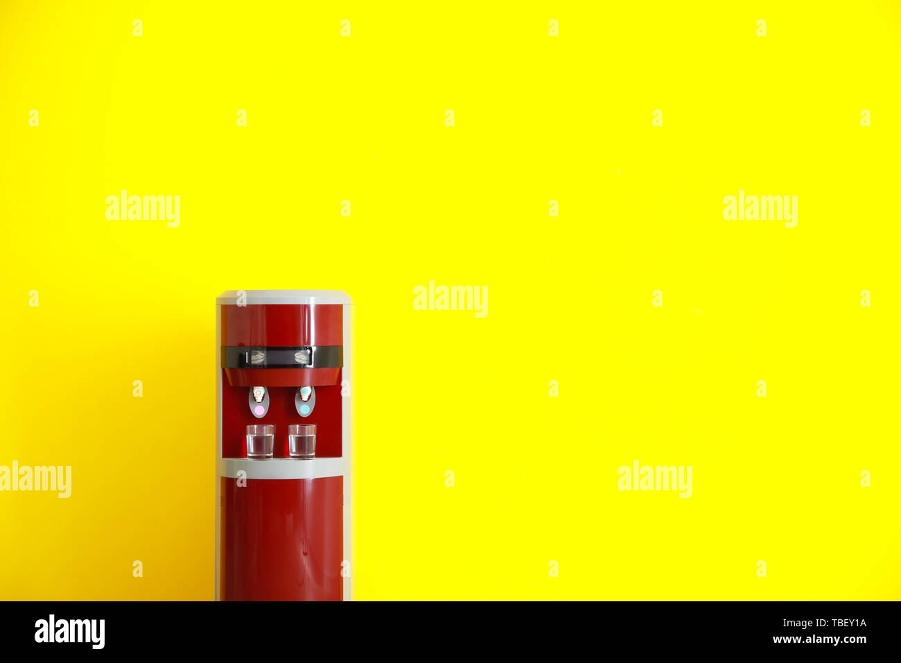 Modern water cooler on color background Stock Photo - Alamy