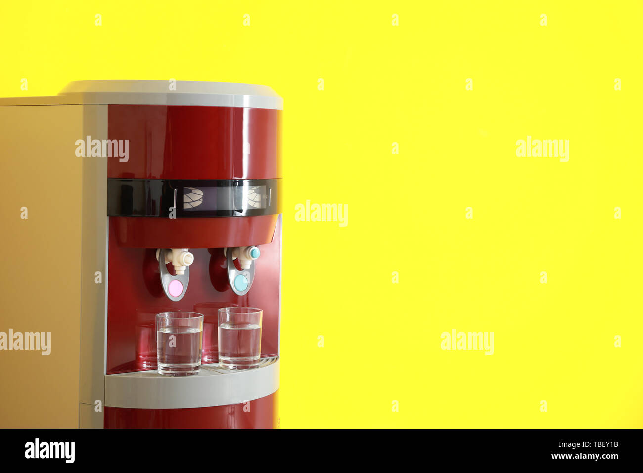 Modern water cooler on color background Stock Photo - Alamy