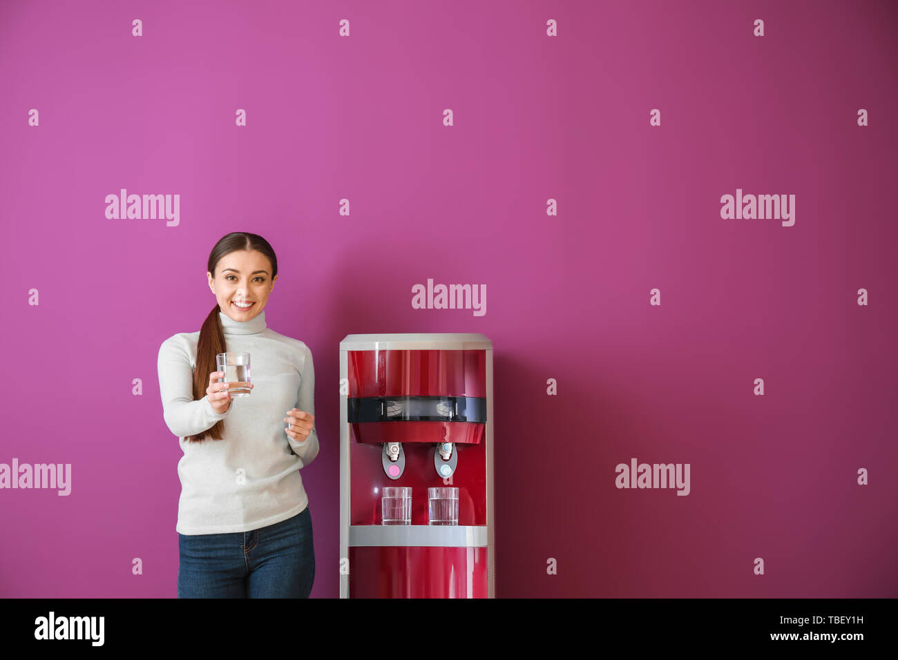 Woman by water cooler hi-res stock photography and images - Alamy