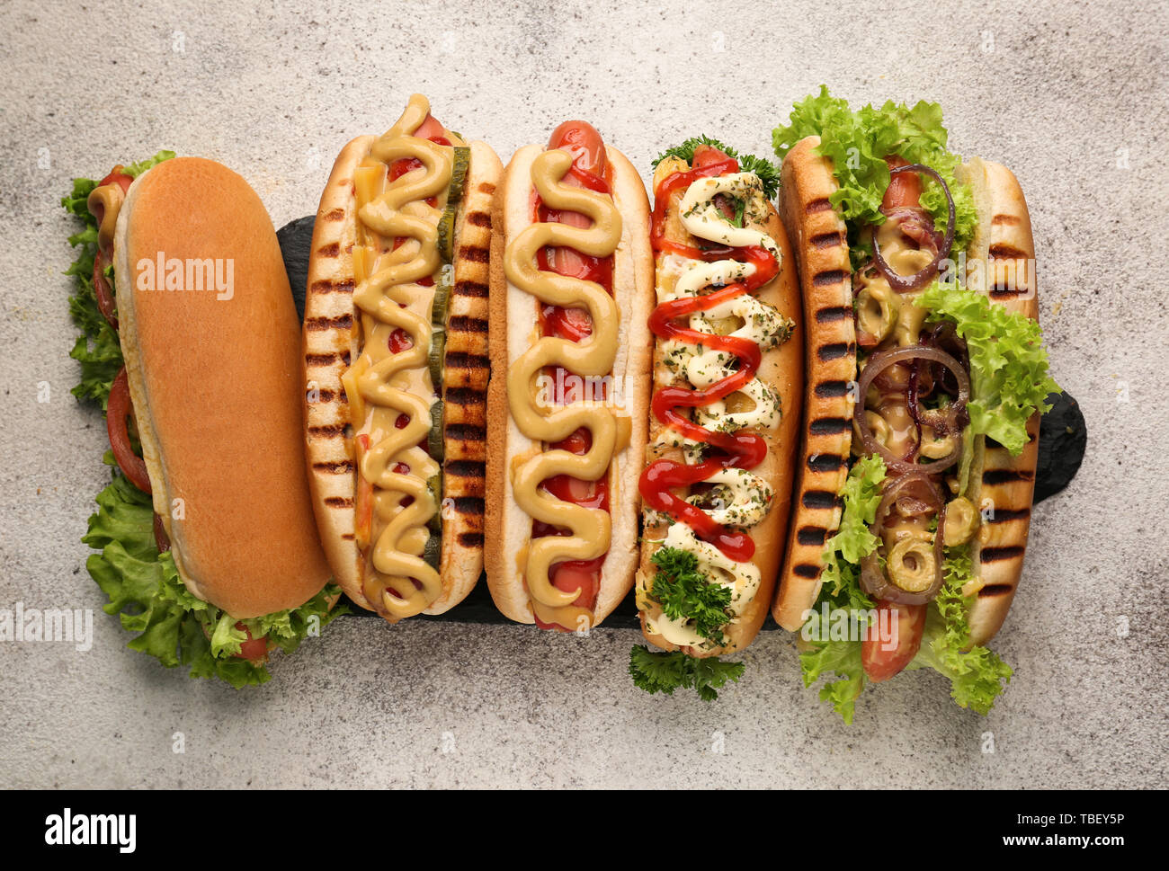 Tasty hot dogs on light table Stock Photo - Alamy