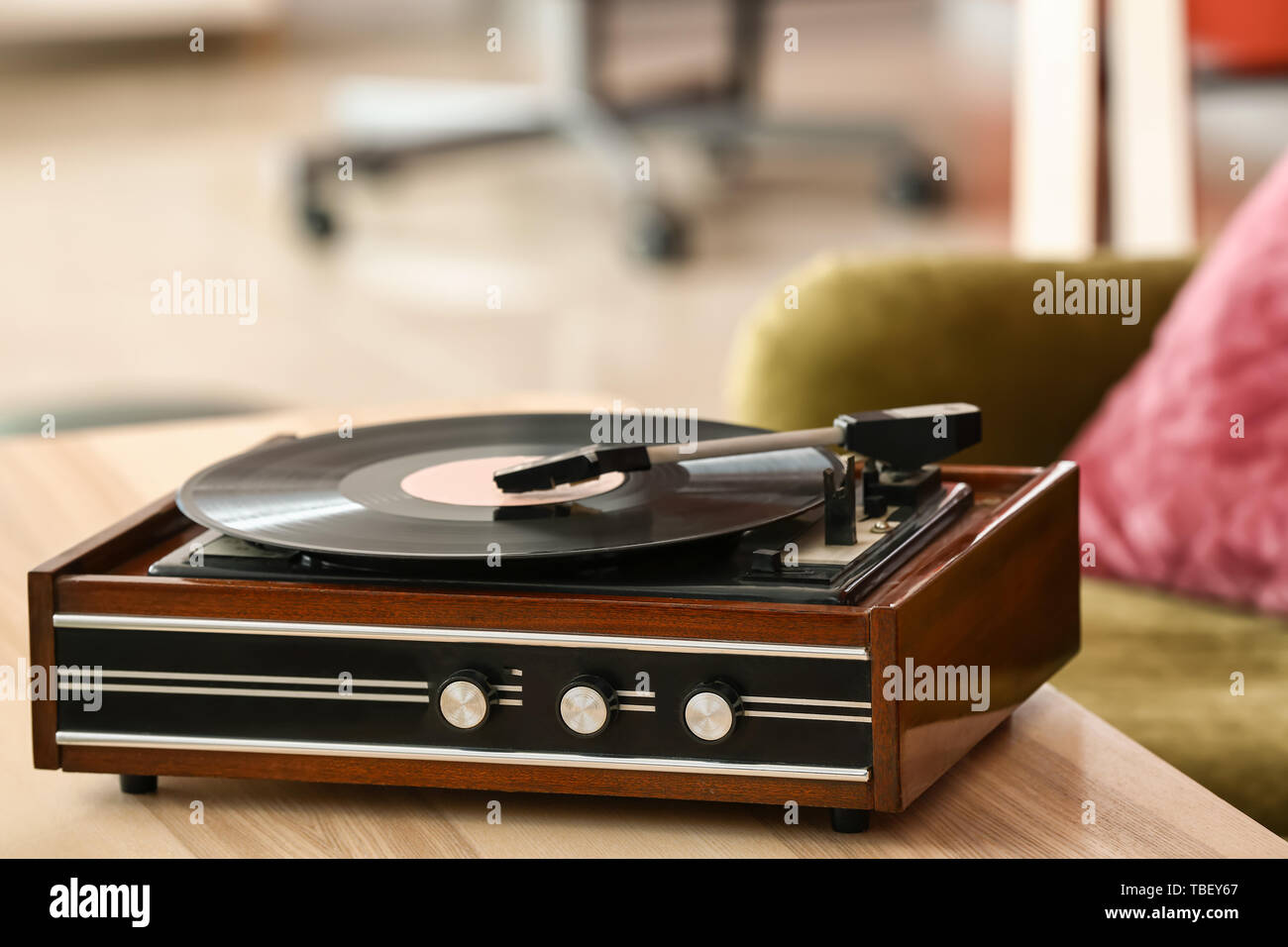 Record player with vinyl disc on table in room Stock Photo - Alamy