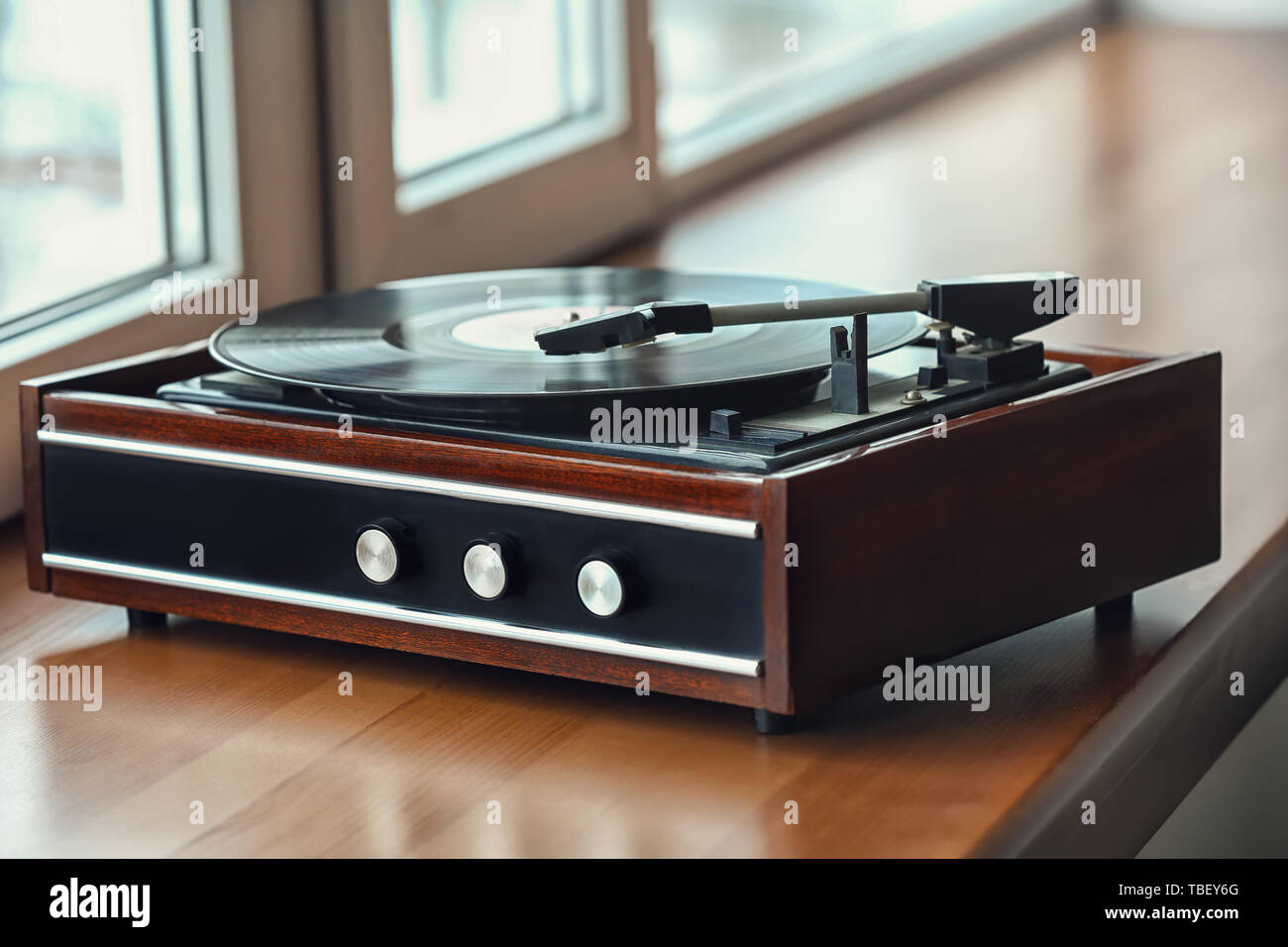 Record player with vinyl disc near window Stock Photo - Alamy