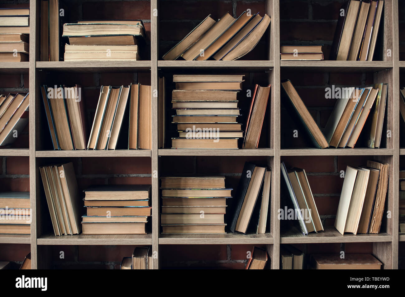Books on shelves in library Stock Photo - Alamy