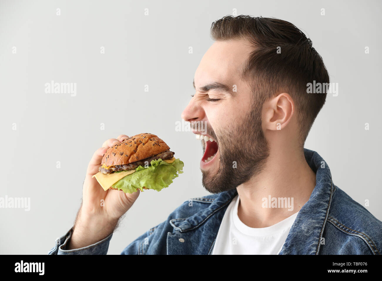 Man eating snack light hi-res stock photography and images - Alamy