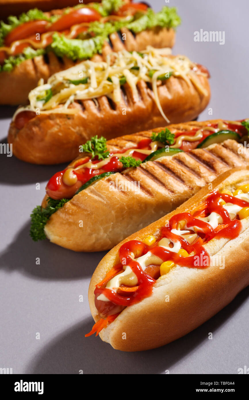 Tasty hot dogs on grey background Stock Photo - Alamy