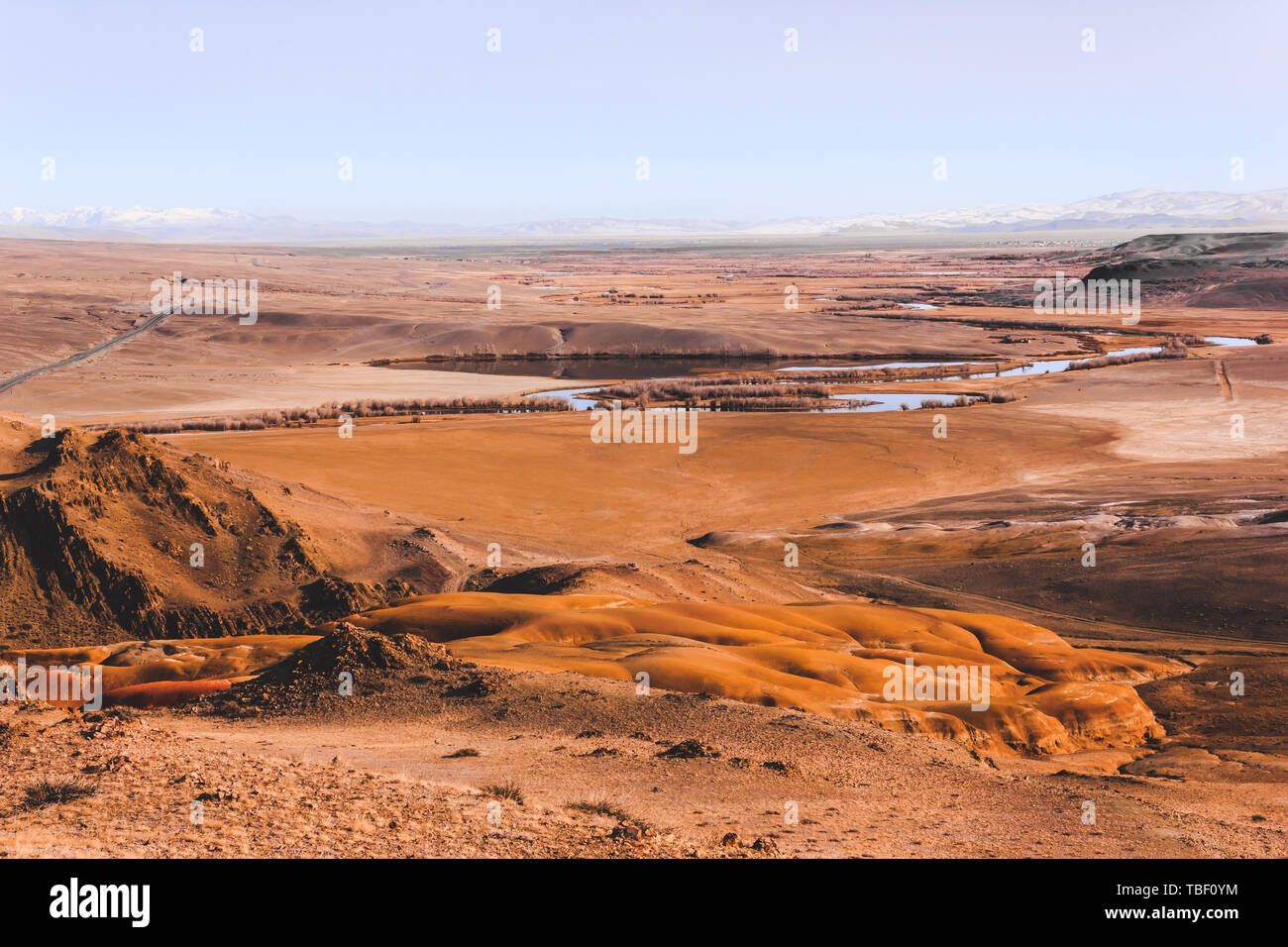Steppe plain with yellow sand. Yellow soil under hot sun. Mountain ...