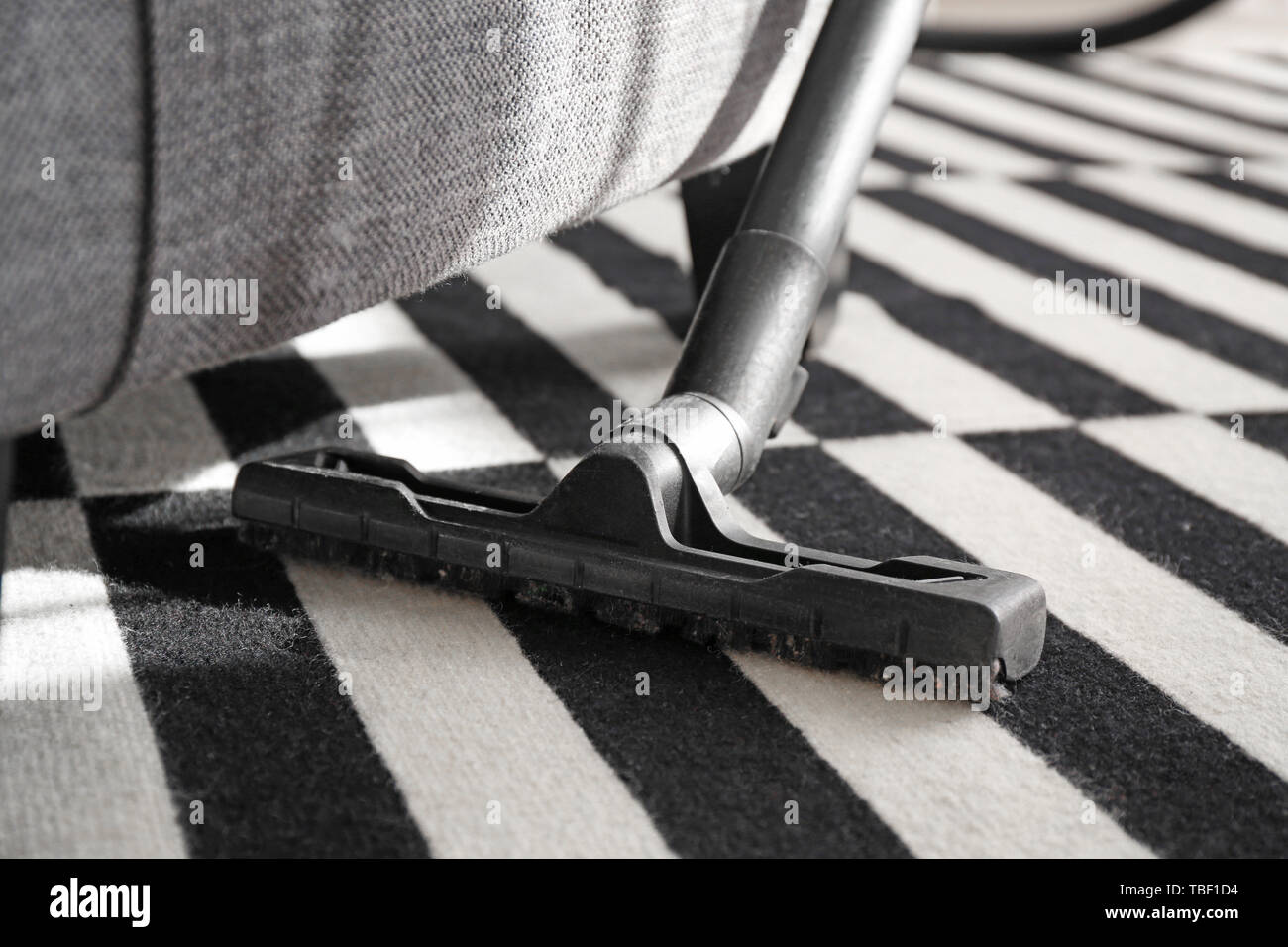 Hoovering of carpet with vacuum cleaner Stock Photo - Alamy