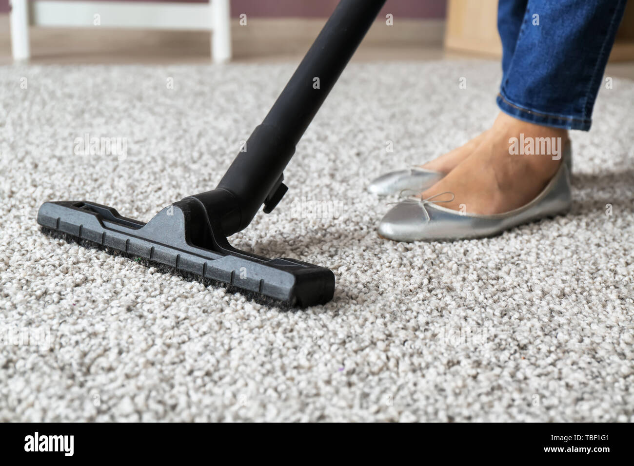 Woman hoovering carpet hi-res stock photography and images - Alamy