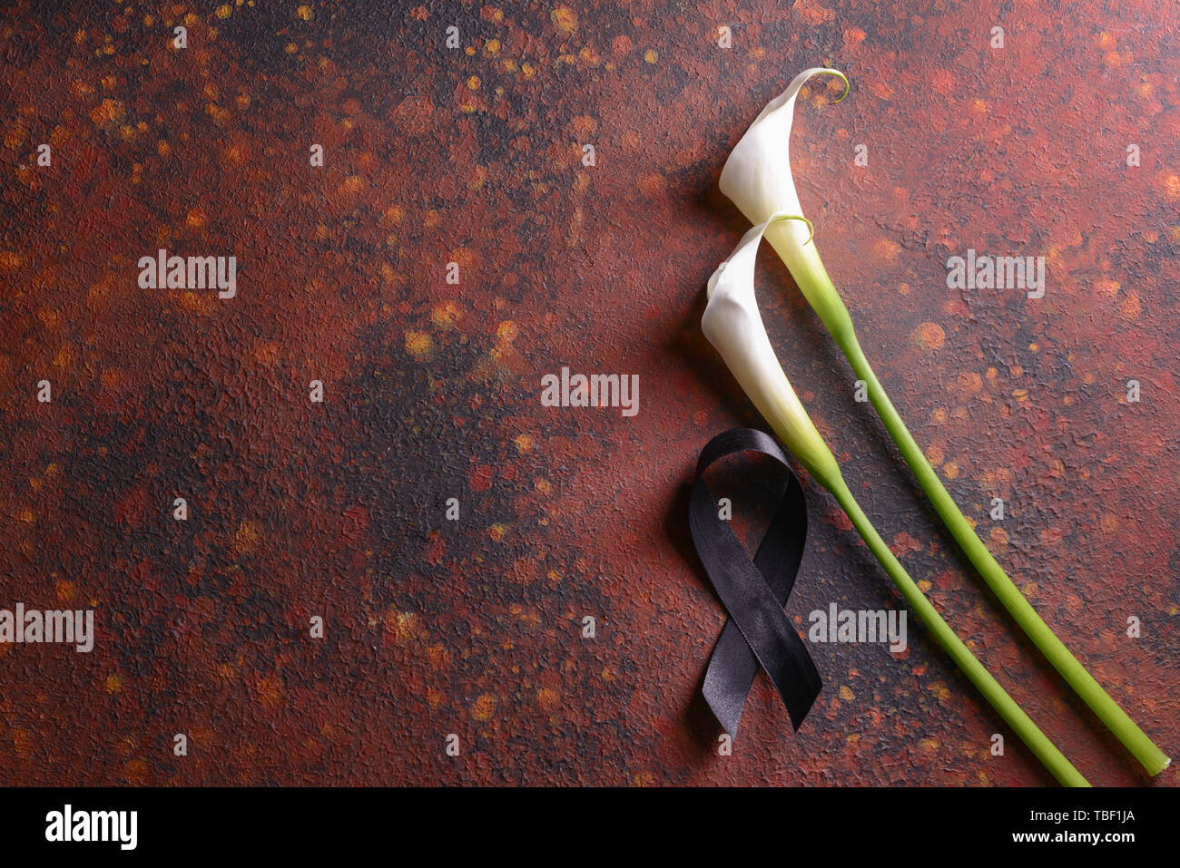 Black funeral ribbon and flowers on grunge background Stock Photo - Alamy