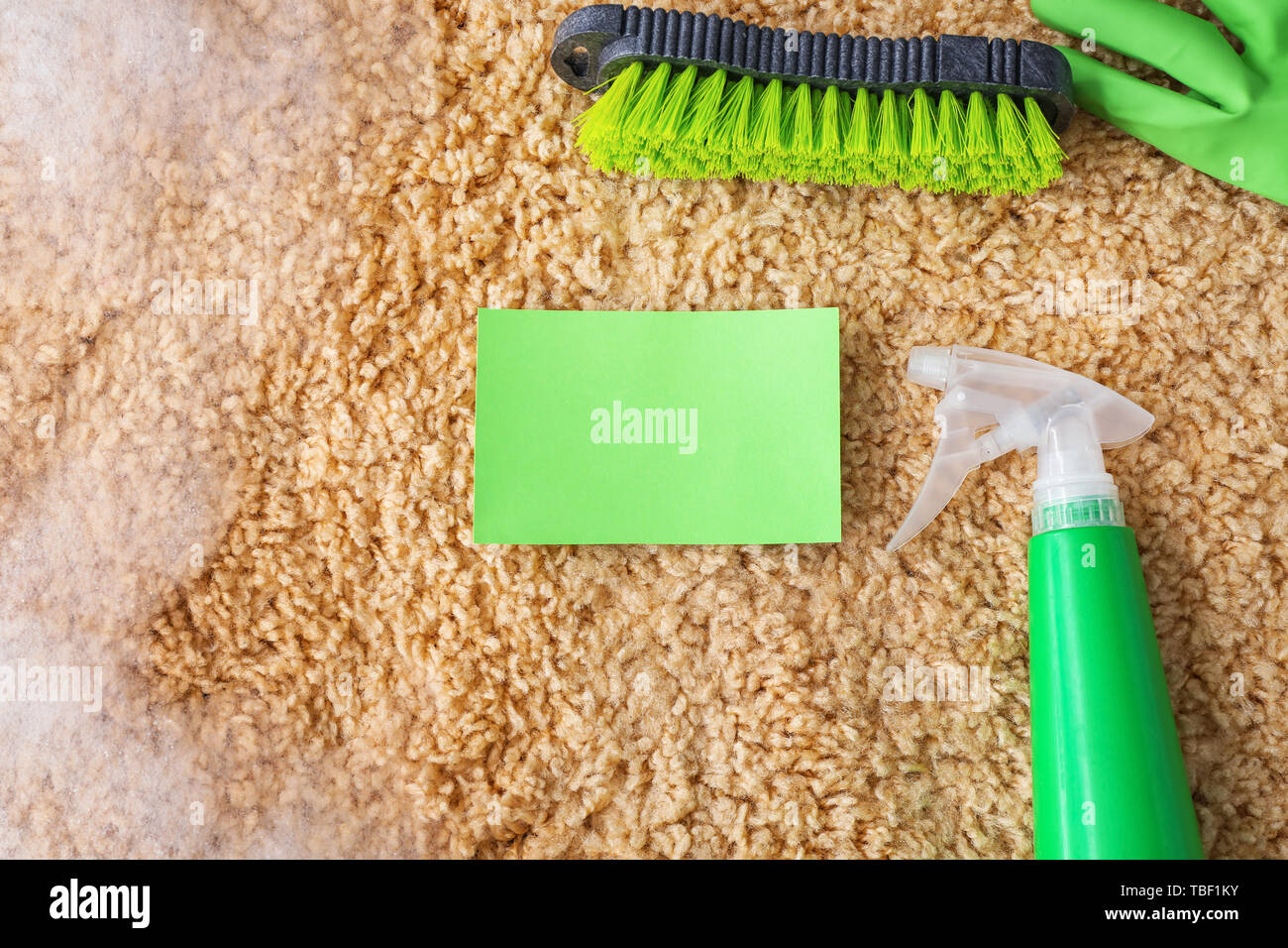 Empty card with cleaning supplies on soft carpet Stock Photo - Alamy
