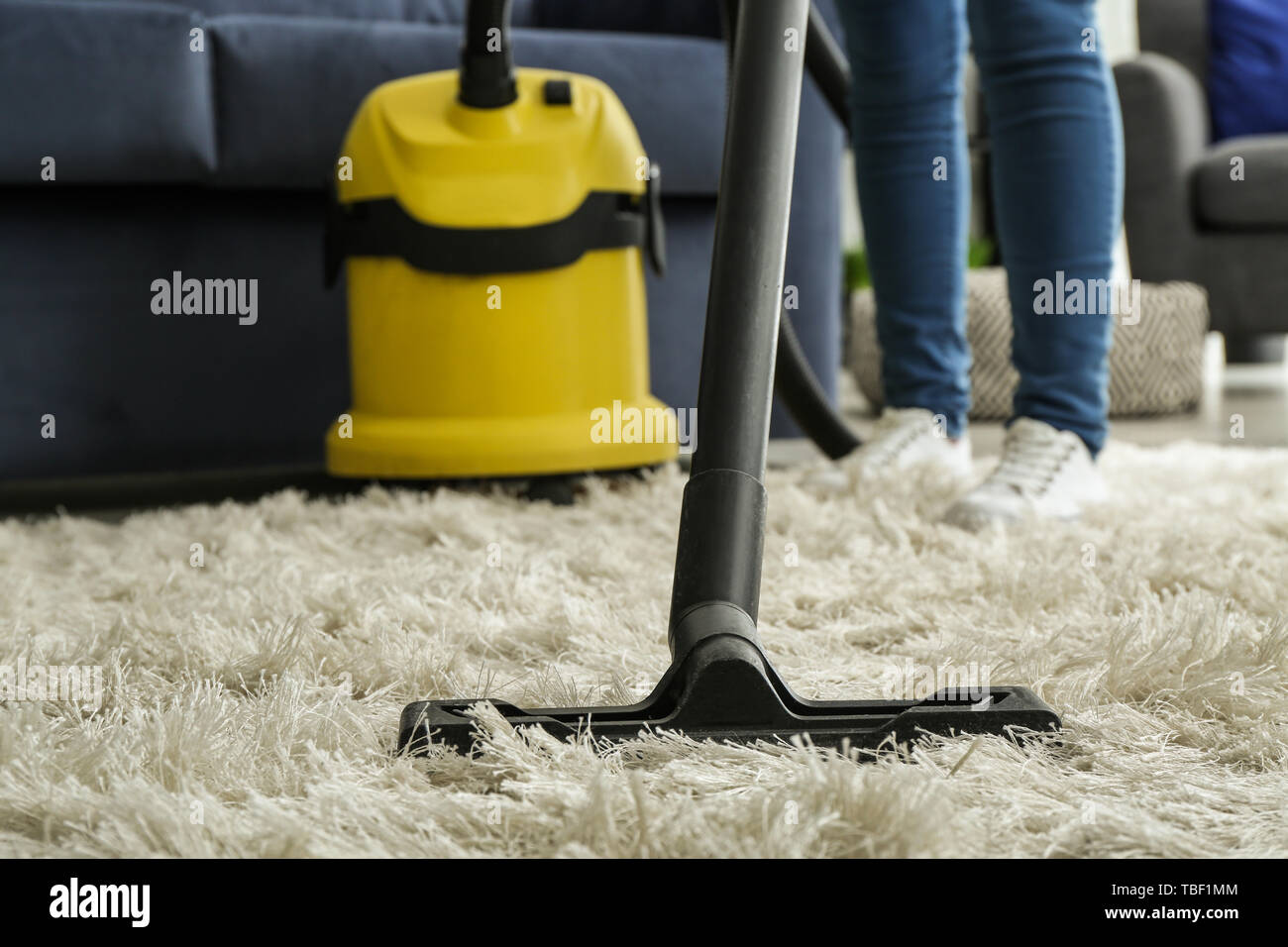 Cleaning of carpet with hoover at home Stock Photo - Alamy