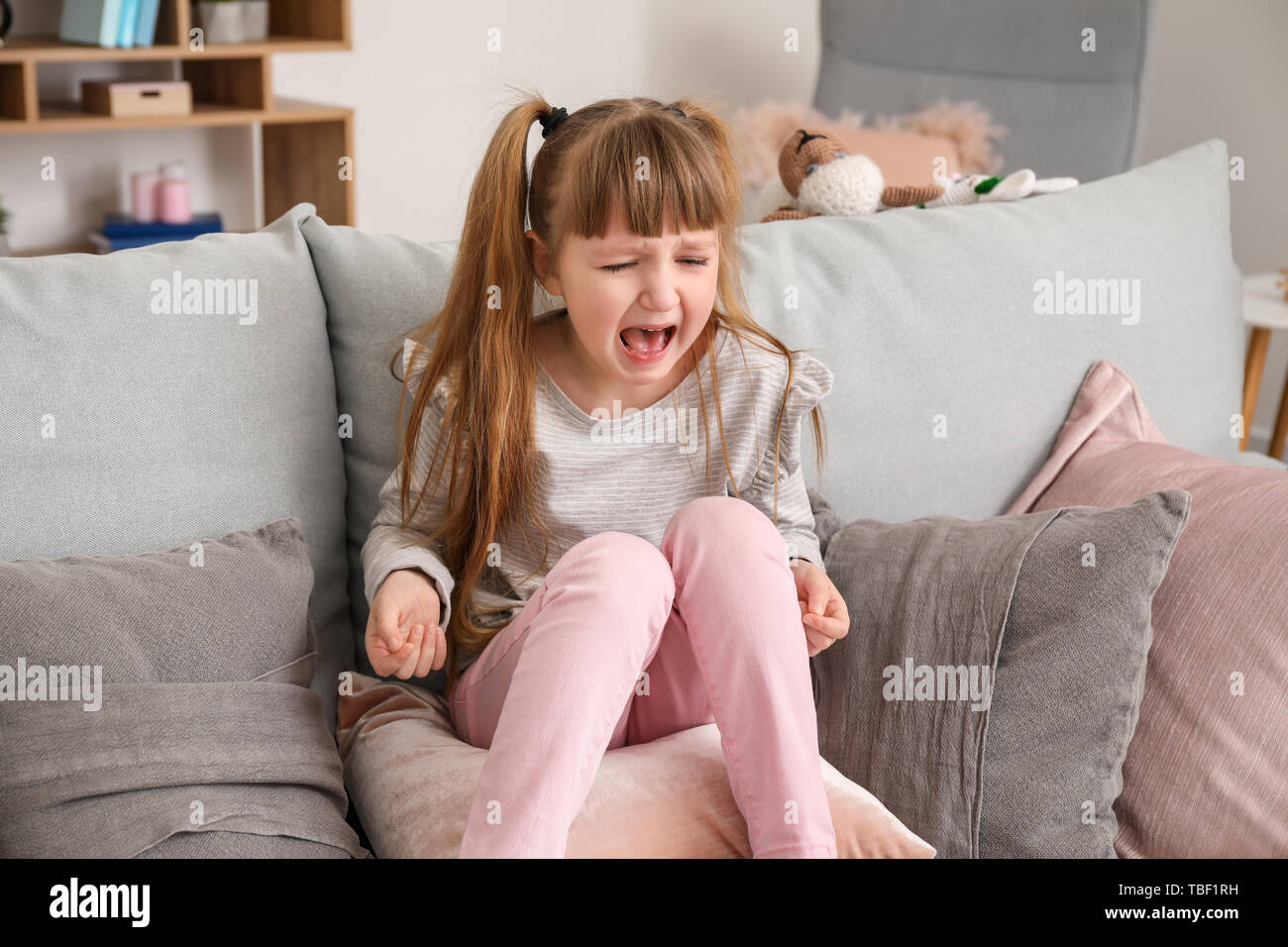Portrait of crying little girl at home Stock Photo - Alamy