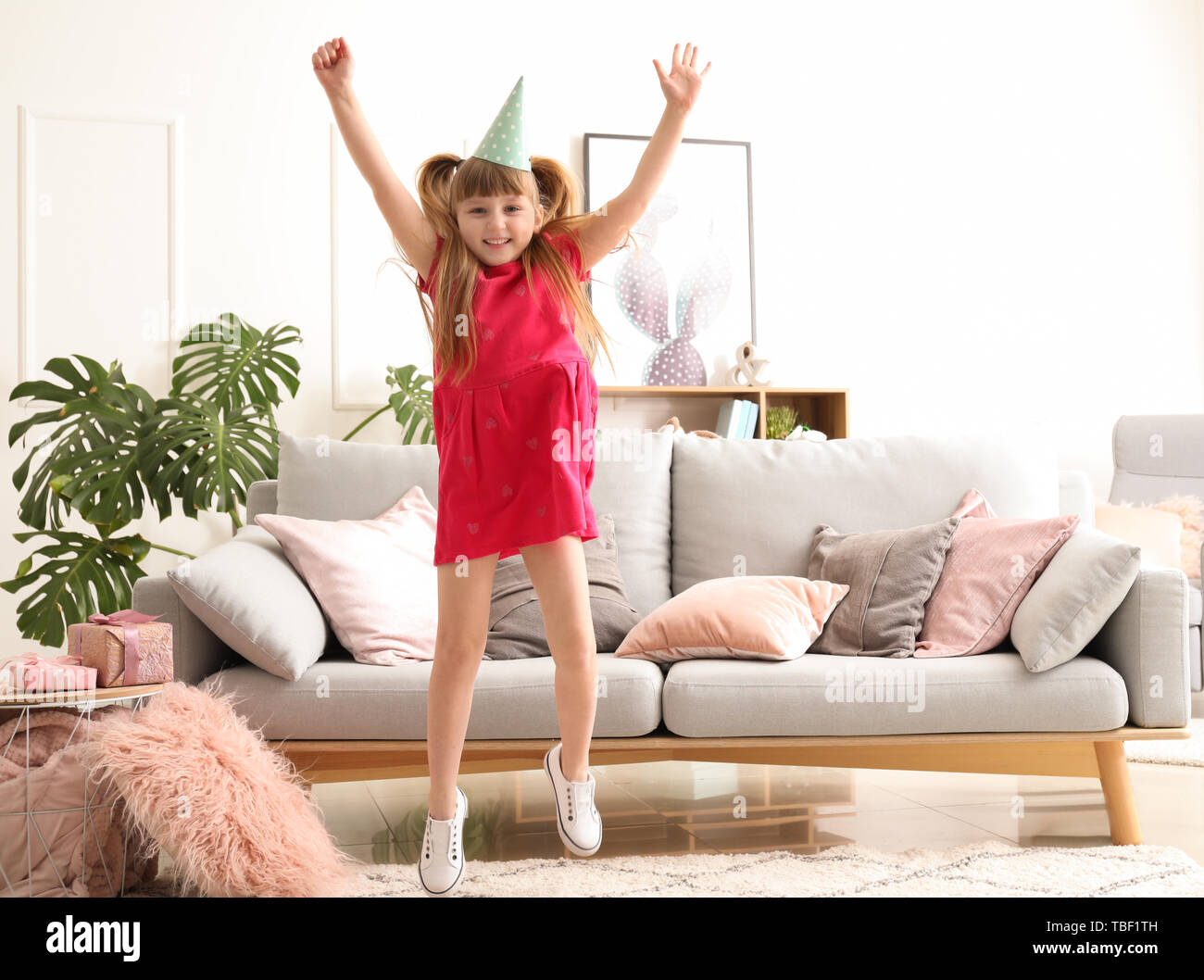 Jumping little girl at Birthday party Stock Photo - Alamy