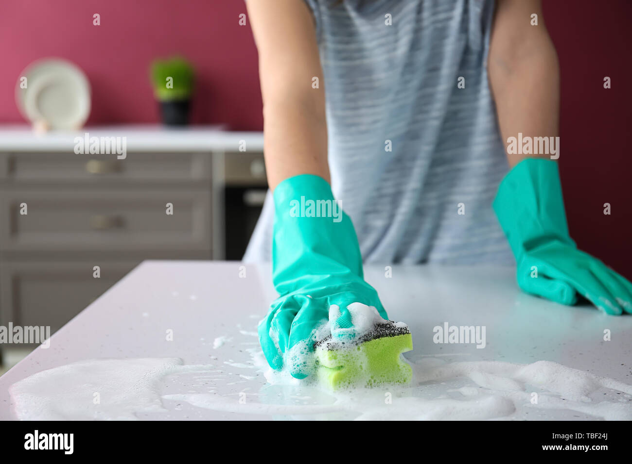 Woman cleaning table in kitchen Stock Photo - Alamy
