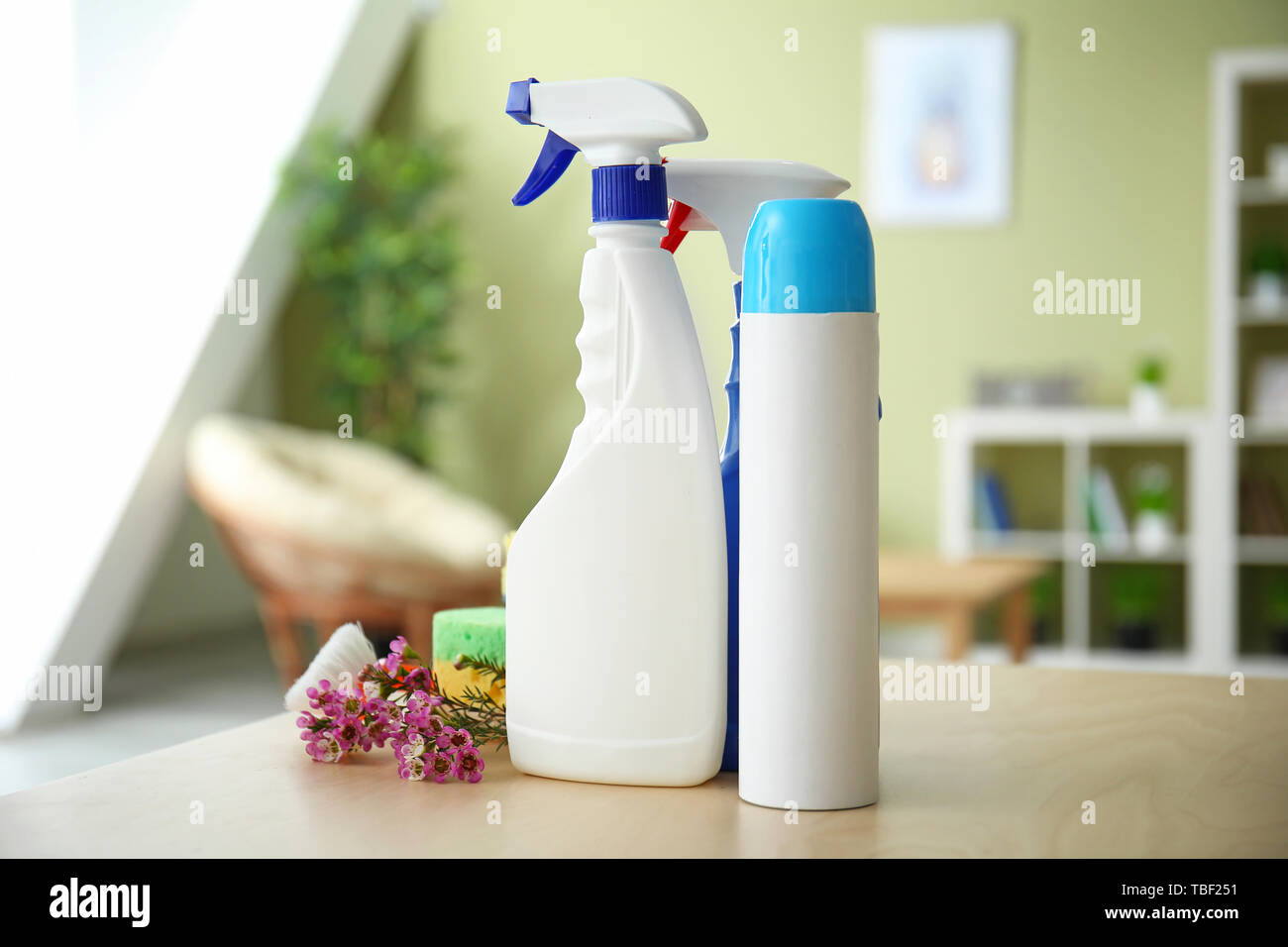 Cleaning supplies on table in room Stock Photo - Alamy