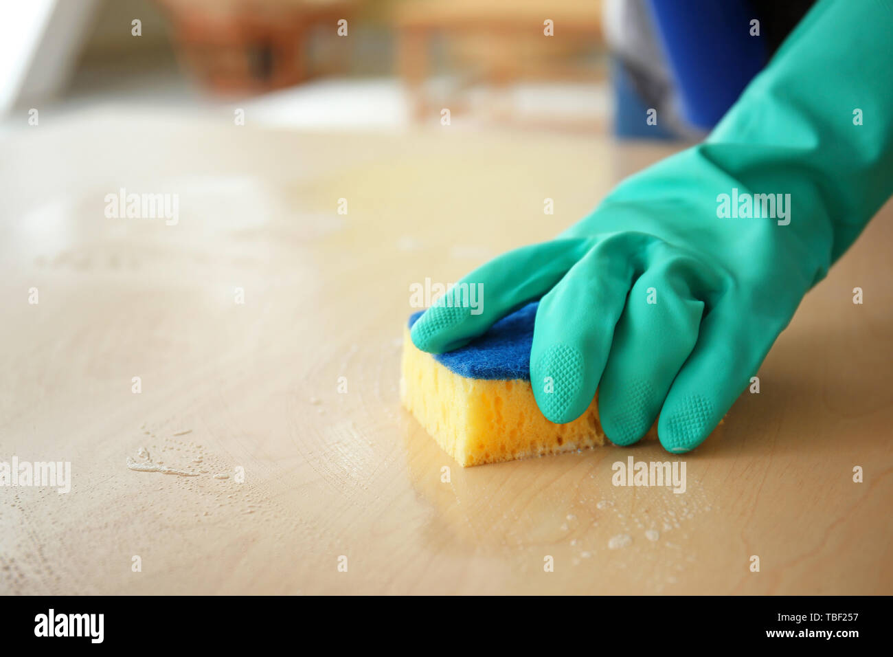 Woman cleaning table in room Stock Photo - Alamy