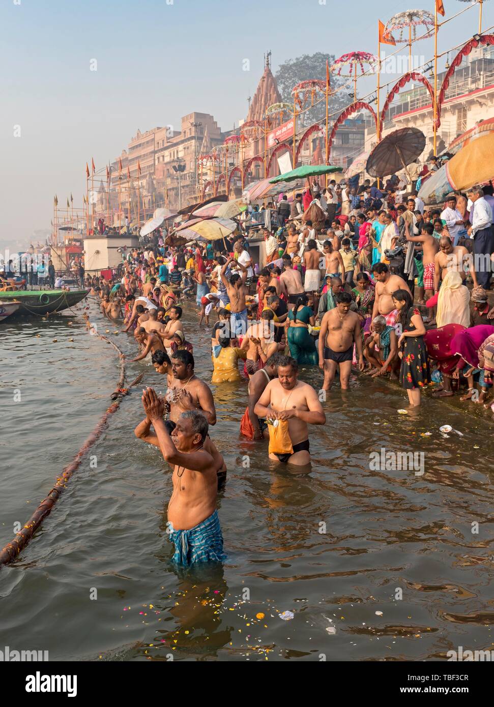 Hindu believers bath and perform ritual bath and puja prayers at ghats ...