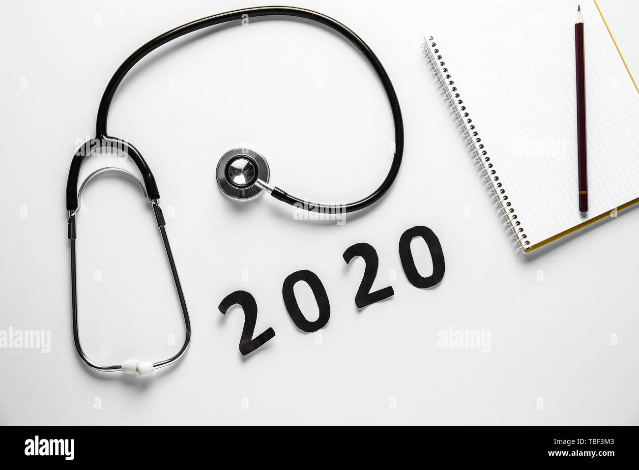 Stethoscope, notebook and figure 2020 on white background Stock Photo ...