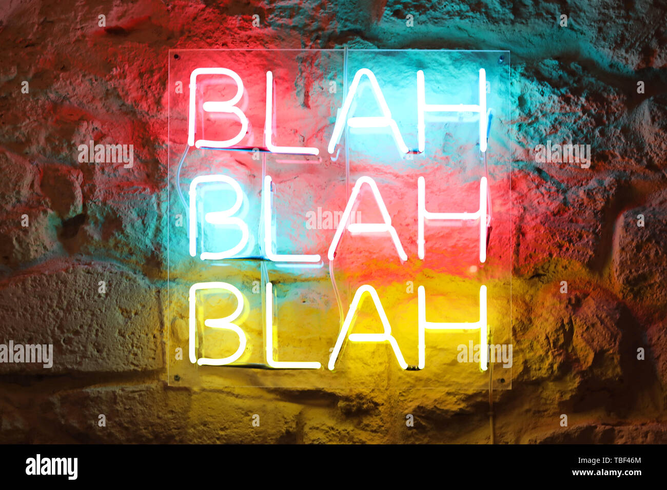 Neon sign on stone wall Stock Photo - Alamy