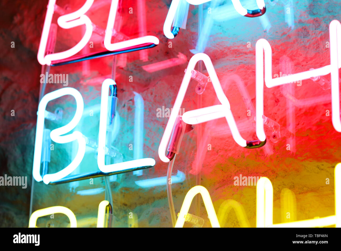 Neon sign on stone wall Stock Photo - Alamy