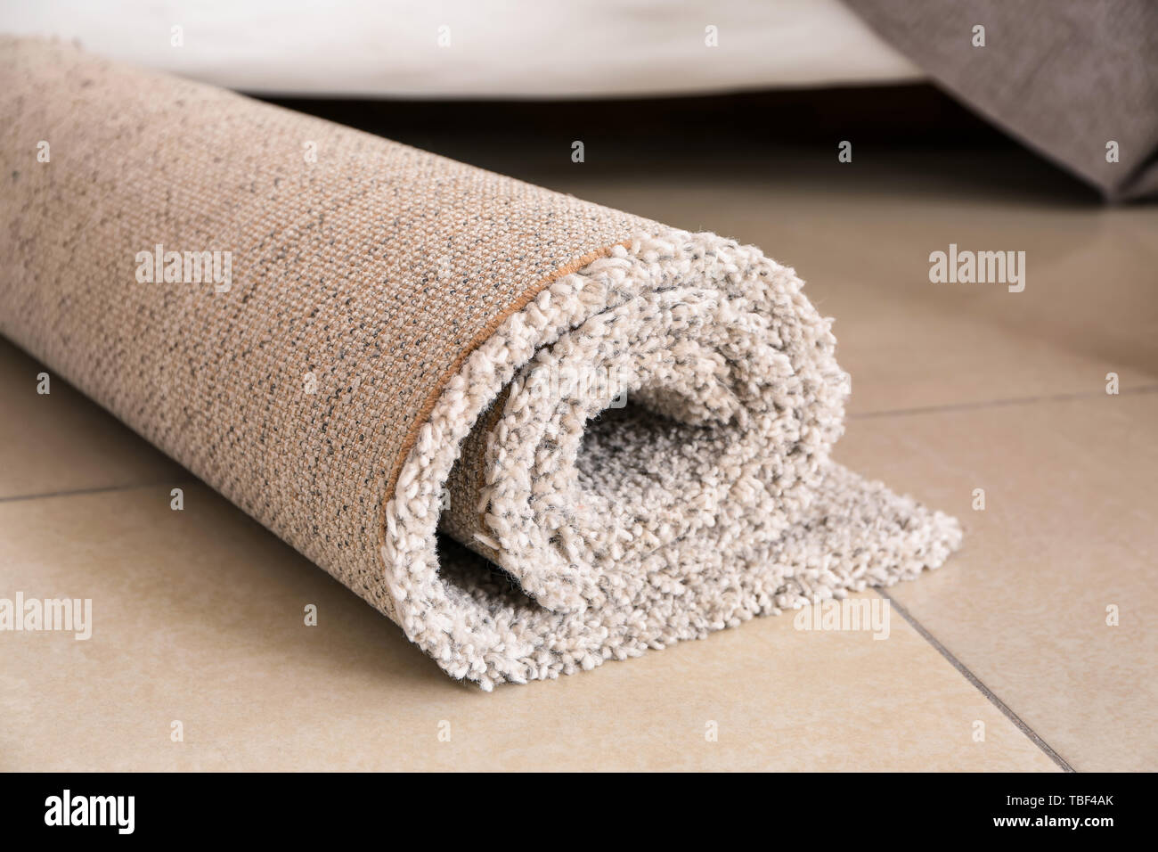Rolled carpet on floor on room Stock Photo - Alamy