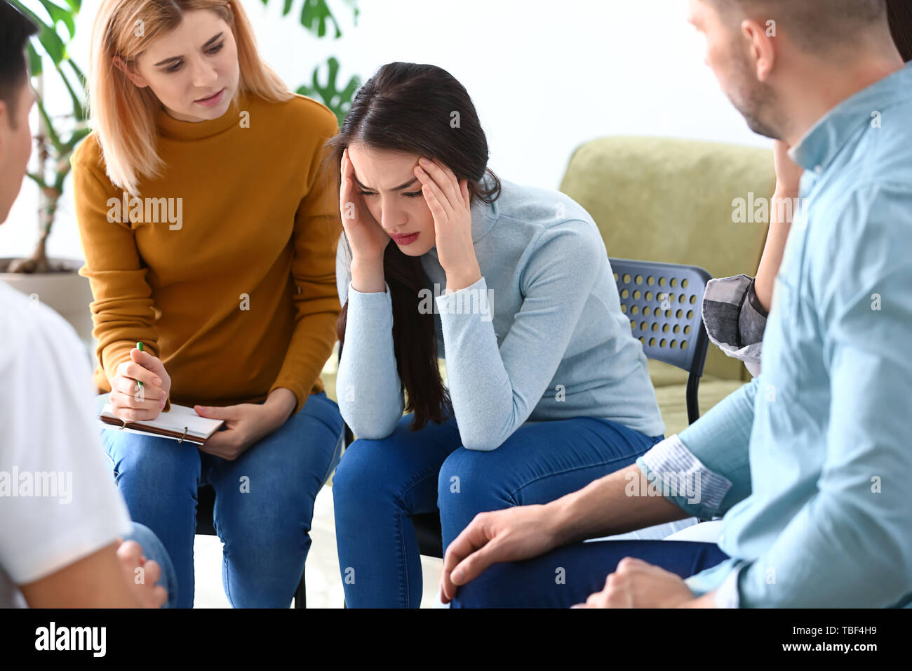 People calming woman at group therapy session Stock Photo - Alamy