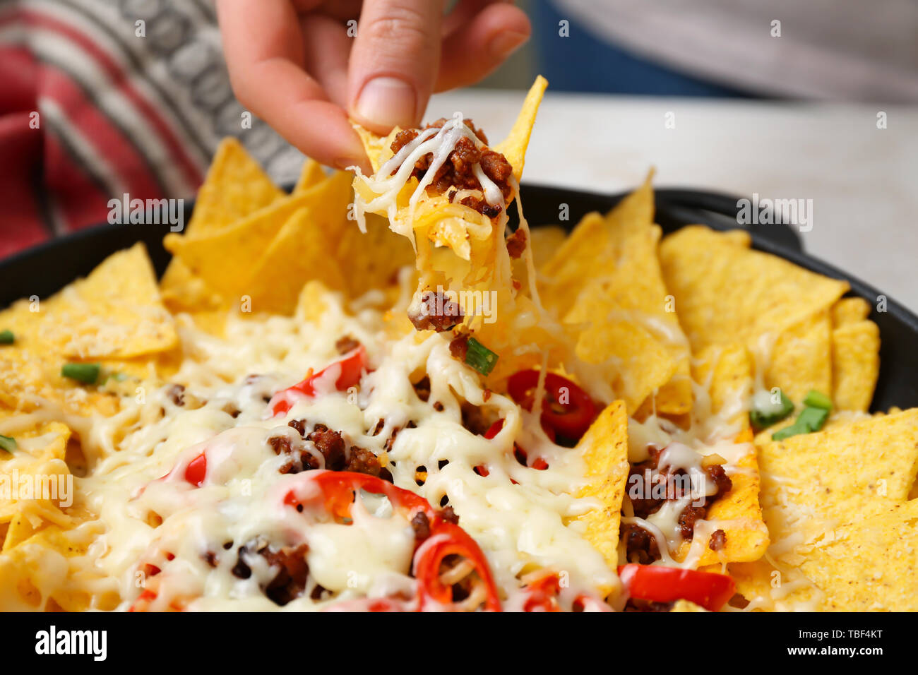 Woman eating tortilla chips hi-res stock photography and images - Alamy