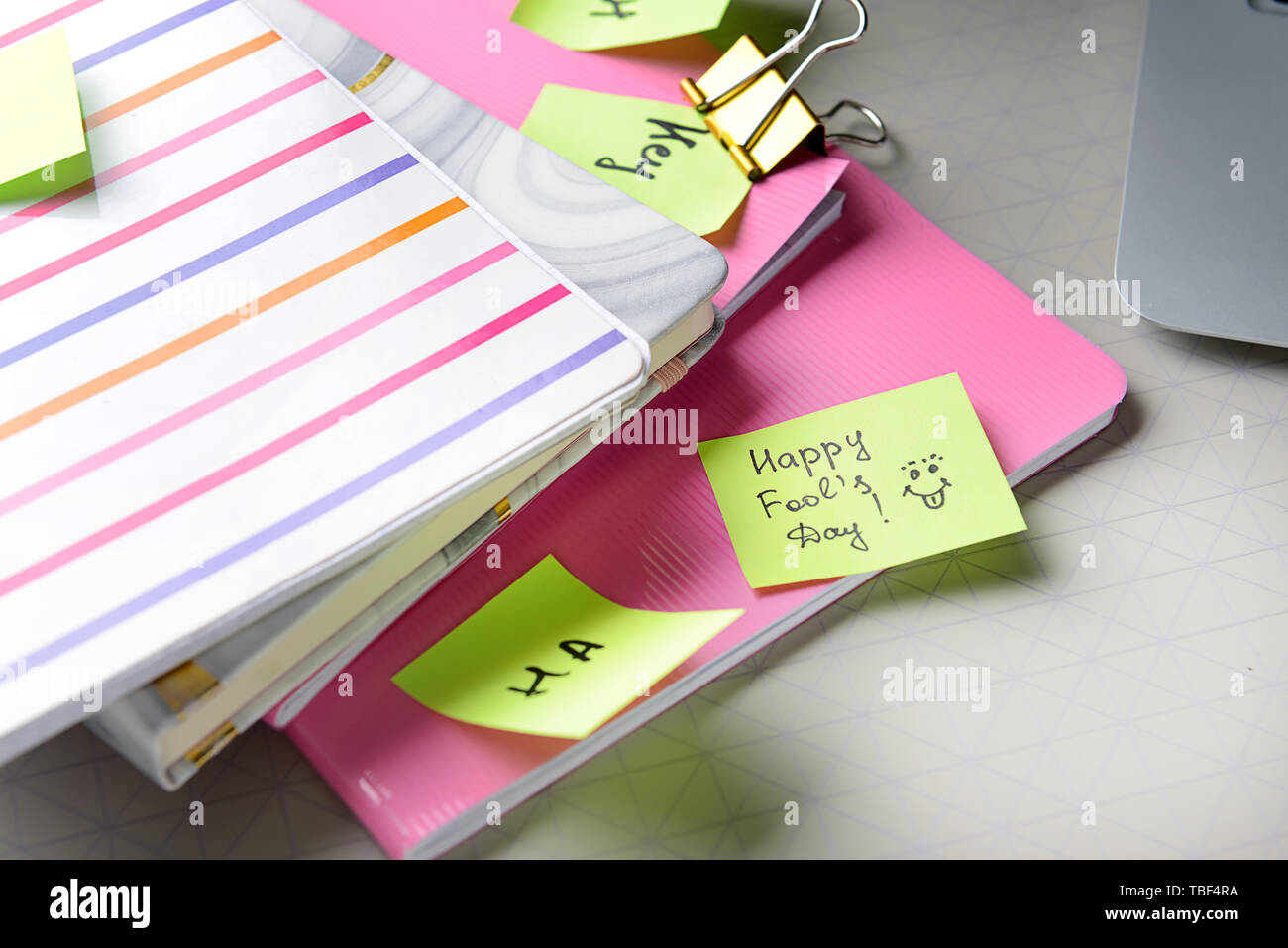 Stationery with sticky notes on grey background. April Fool's Day prank ...