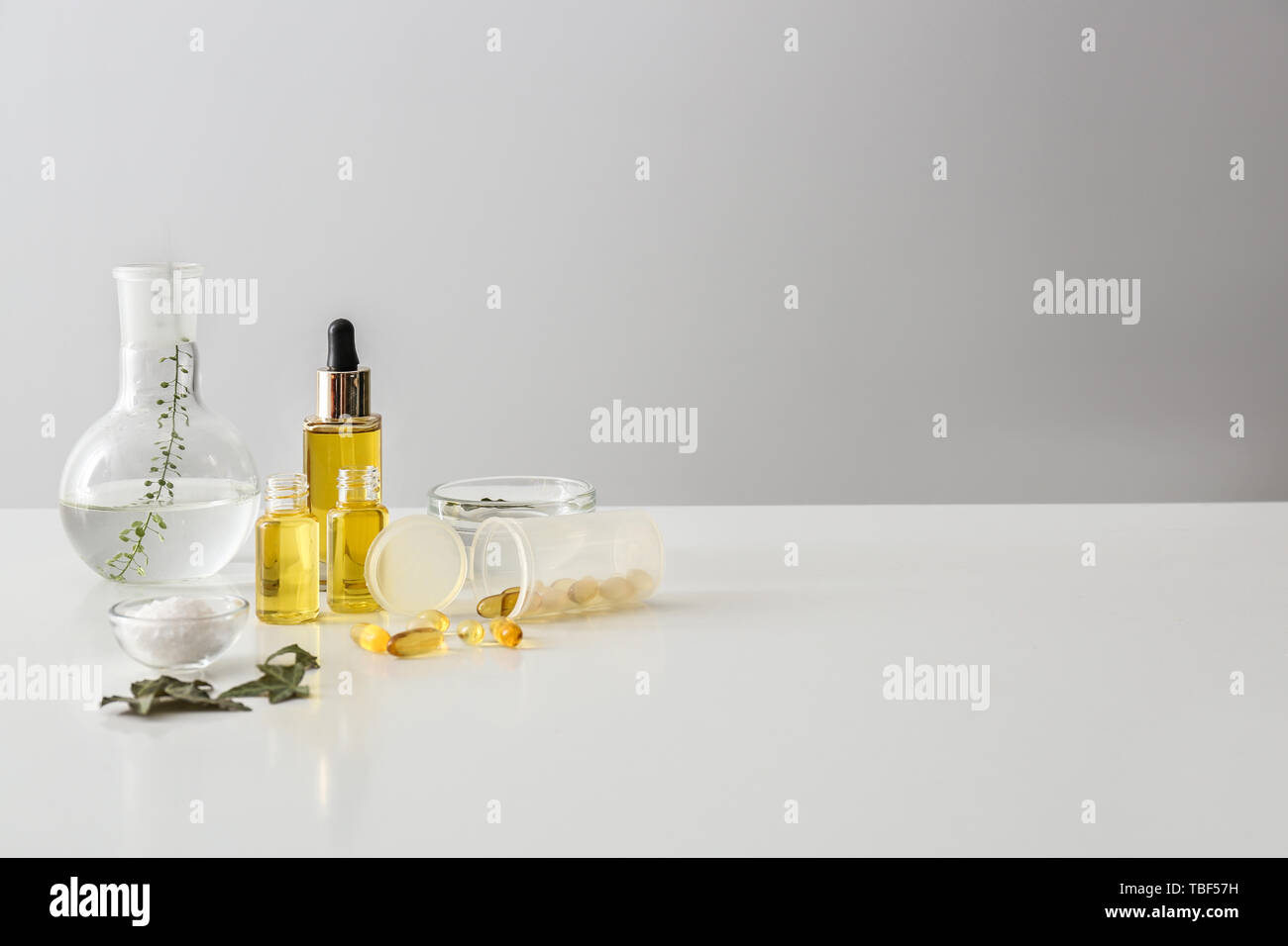 Remedies with natural herbal extract on white table Stock Photo - Alamy