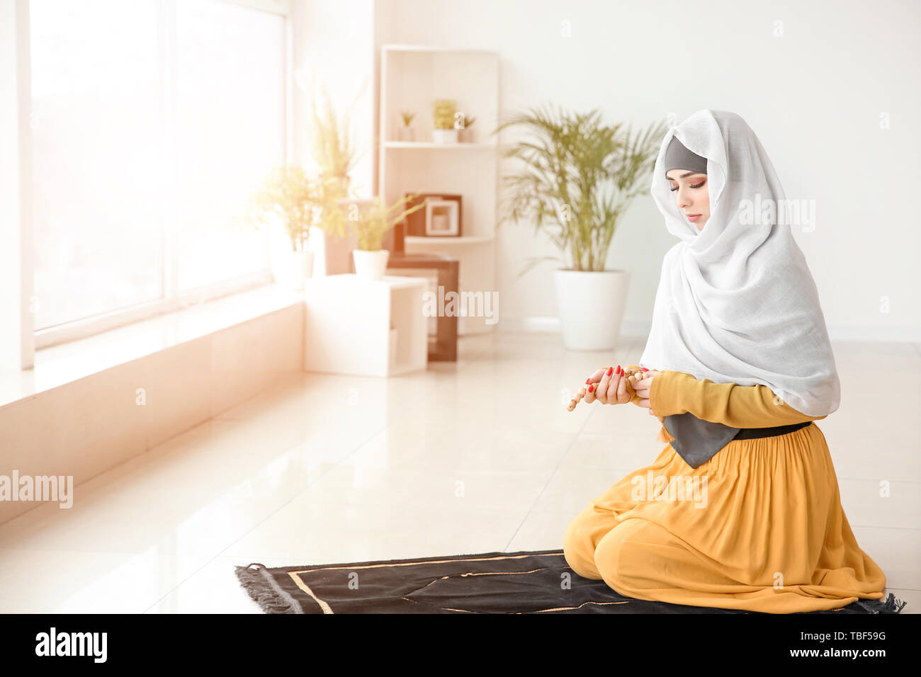 Muslim Woman Praying At Home Young Muslim Woman Praying At Home Stock