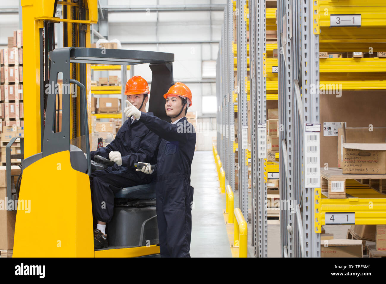 Logistics personnel load and unload cargo at the warehouse Stock Photo ...